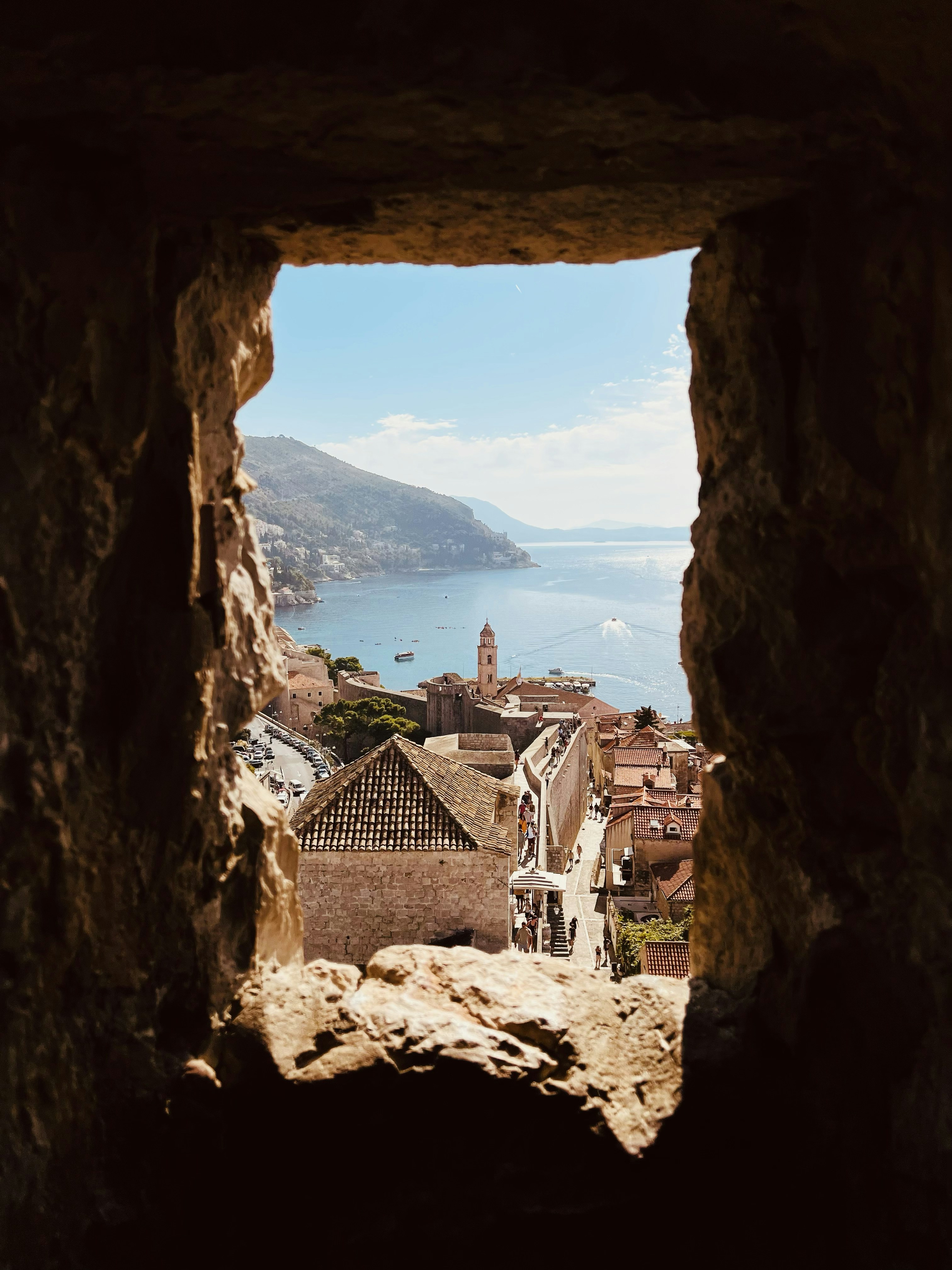 Beautiful coastal view framed by a stone window.