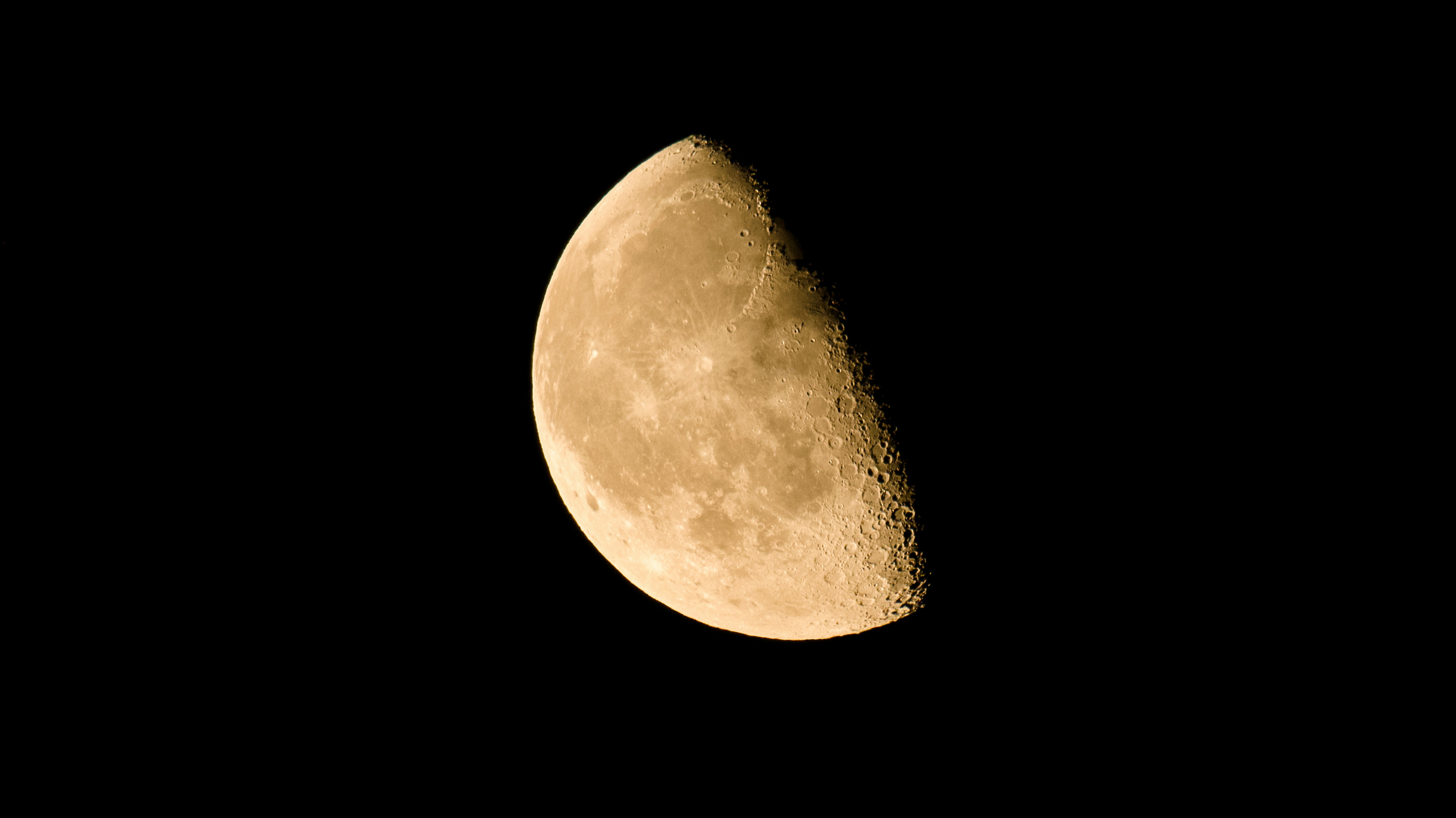 Waxing Gibbous Moon Close-up of the waxing gibbous Moon captured from Sofia, Bulgaria on a clear summer night. Photographed with the Fujifilm X-T5 and XF 150–600mm lens, highlighting the rich crater texture and terminator line. Perfect for use in astronomy, space, or night-themed visuals. | A half moon shines brightly in the night sky.