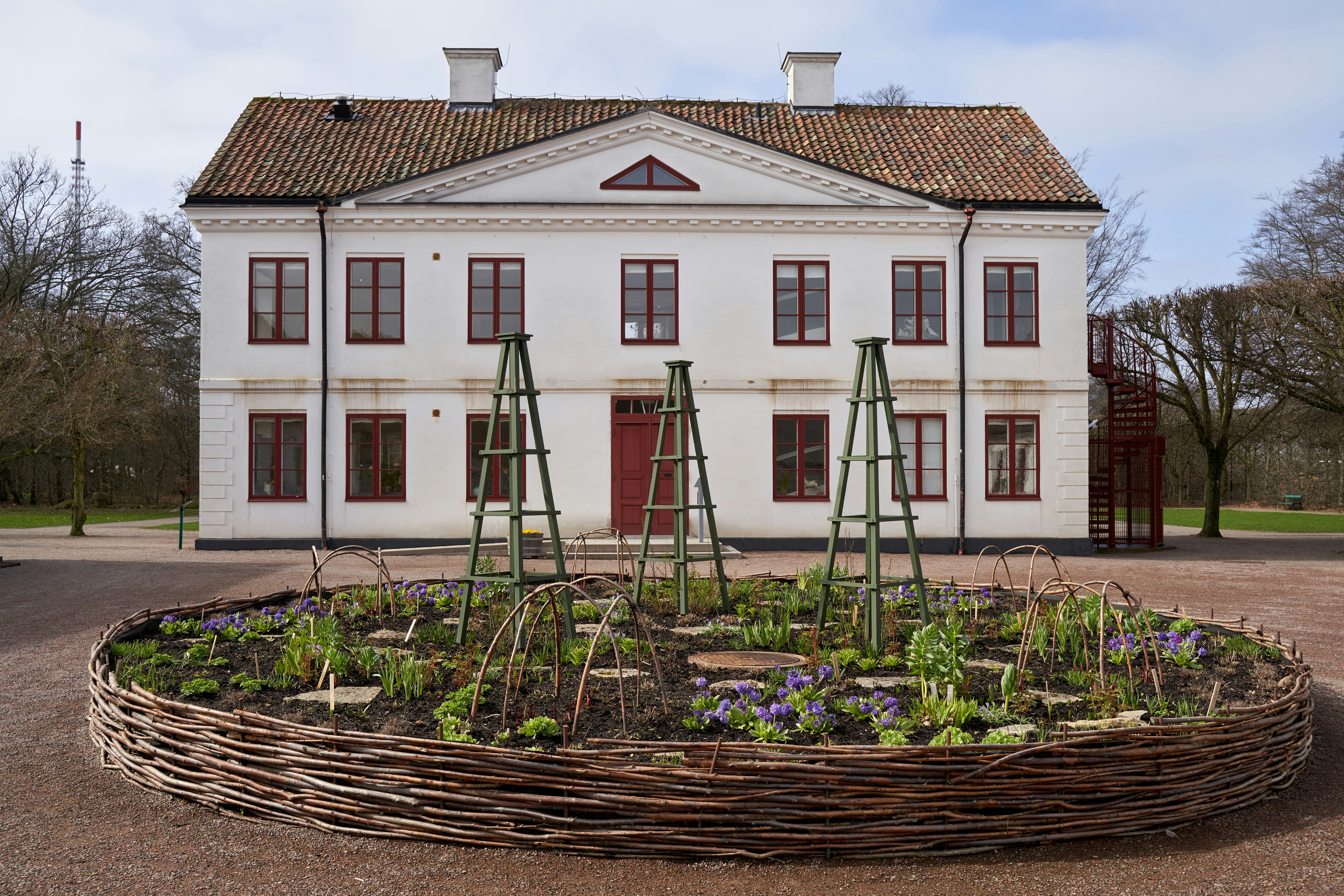 Georgian Manor Framed by a Circular Wicker Garden Bed