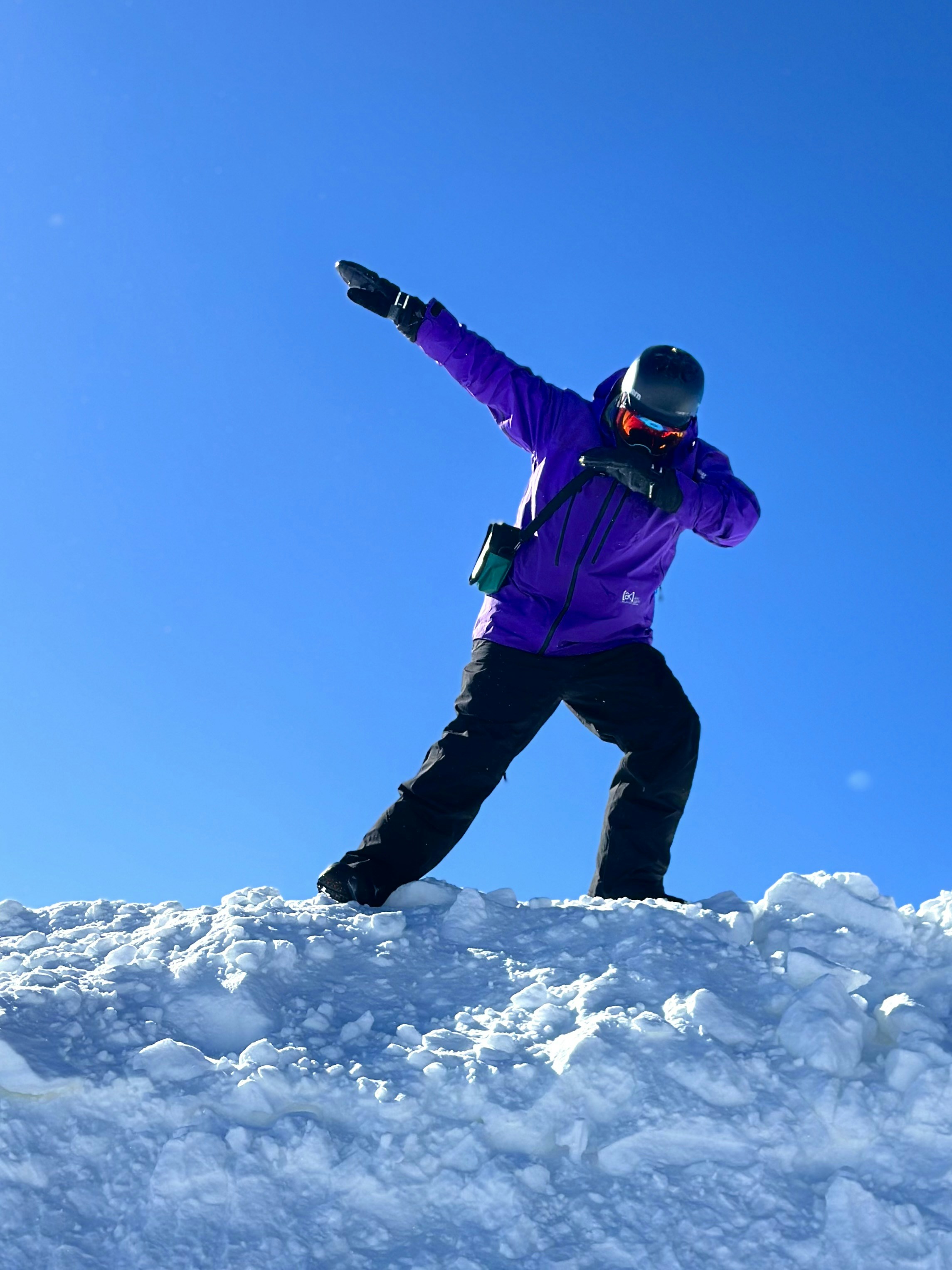 Person dabbing on a snowy mountain.