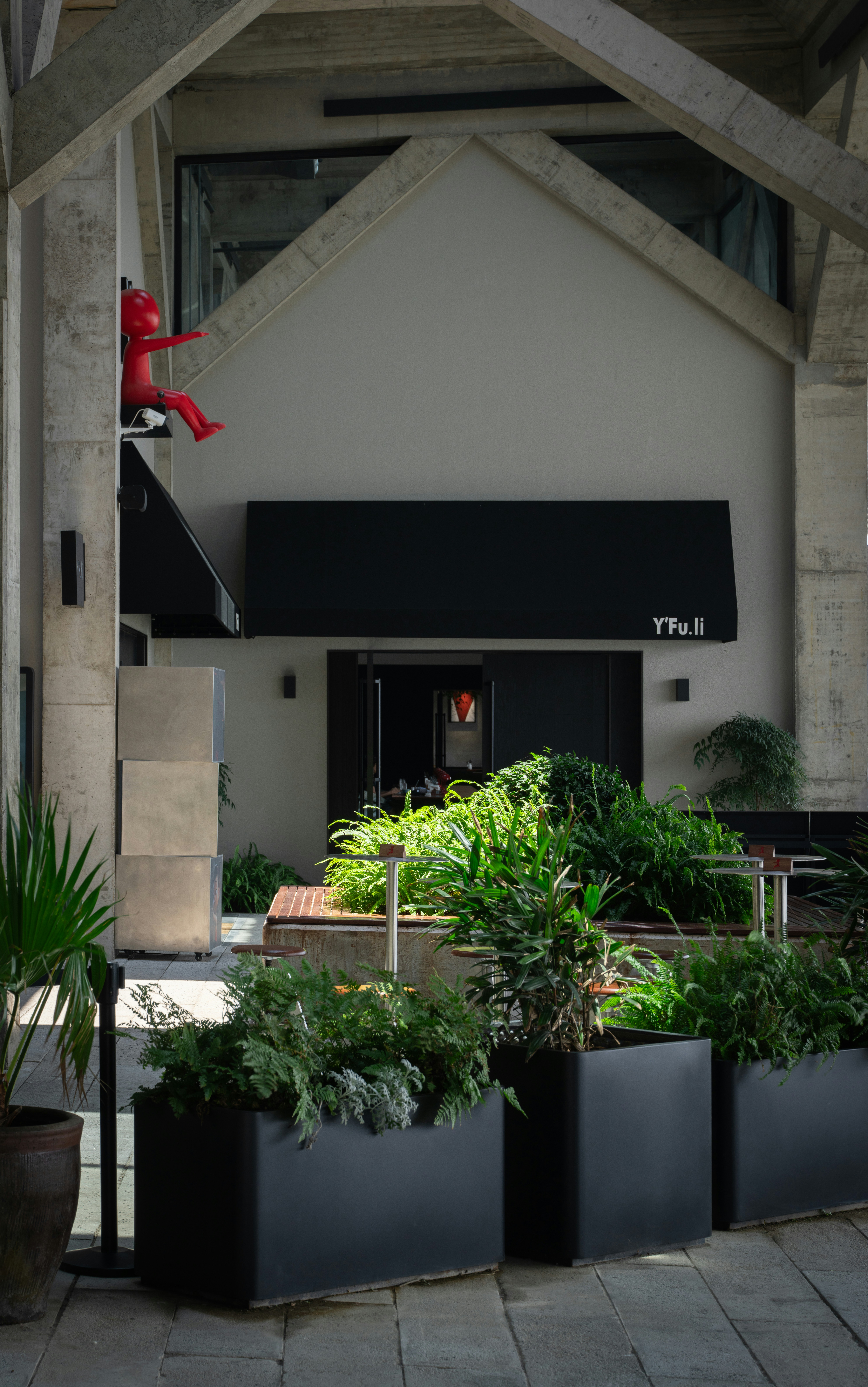 Red Figure on a Concrete Balcony: A Quiet Study of Architecture and Life