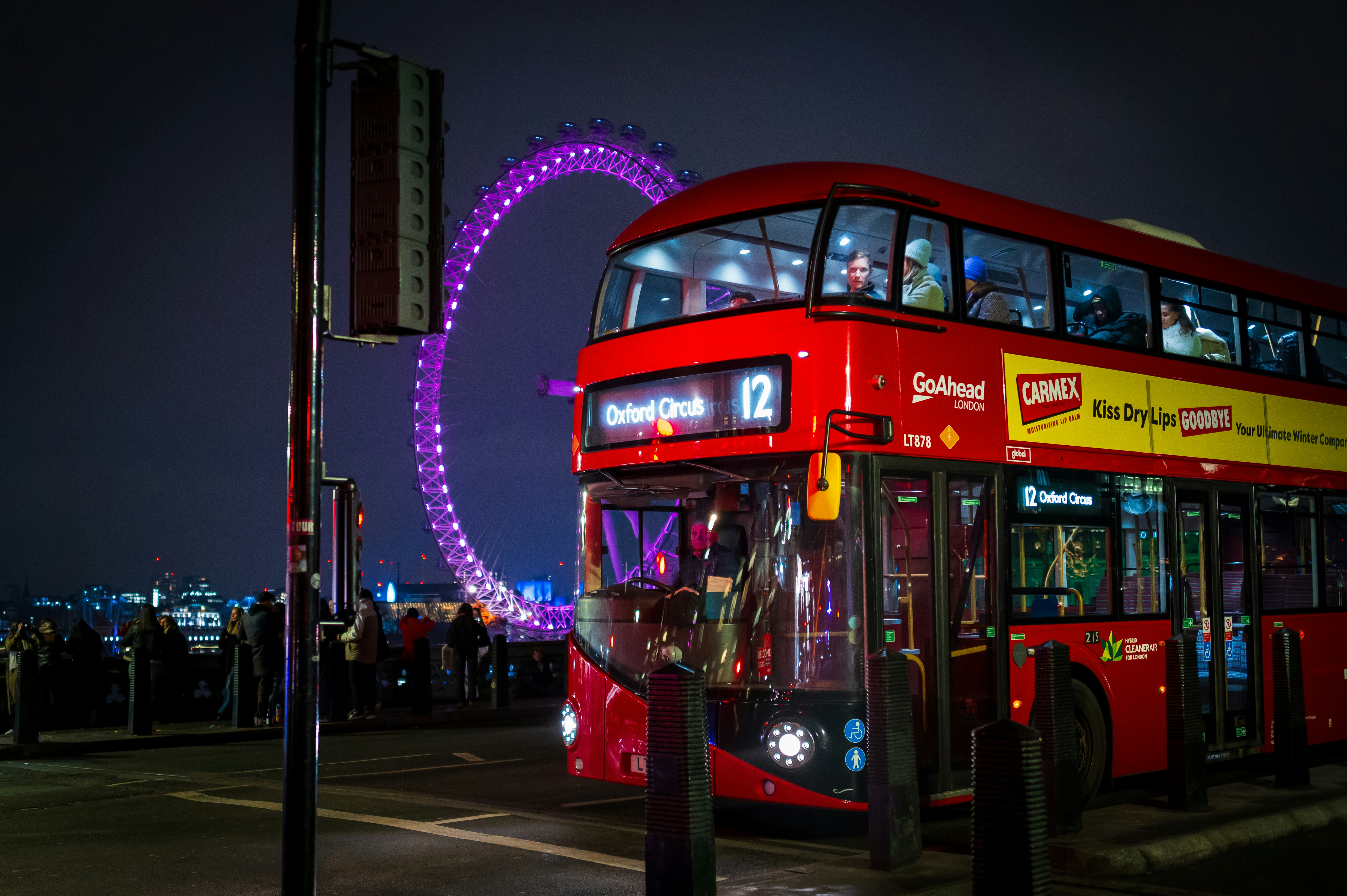 London Night Route: The Red Bus Against the Neon Arc
