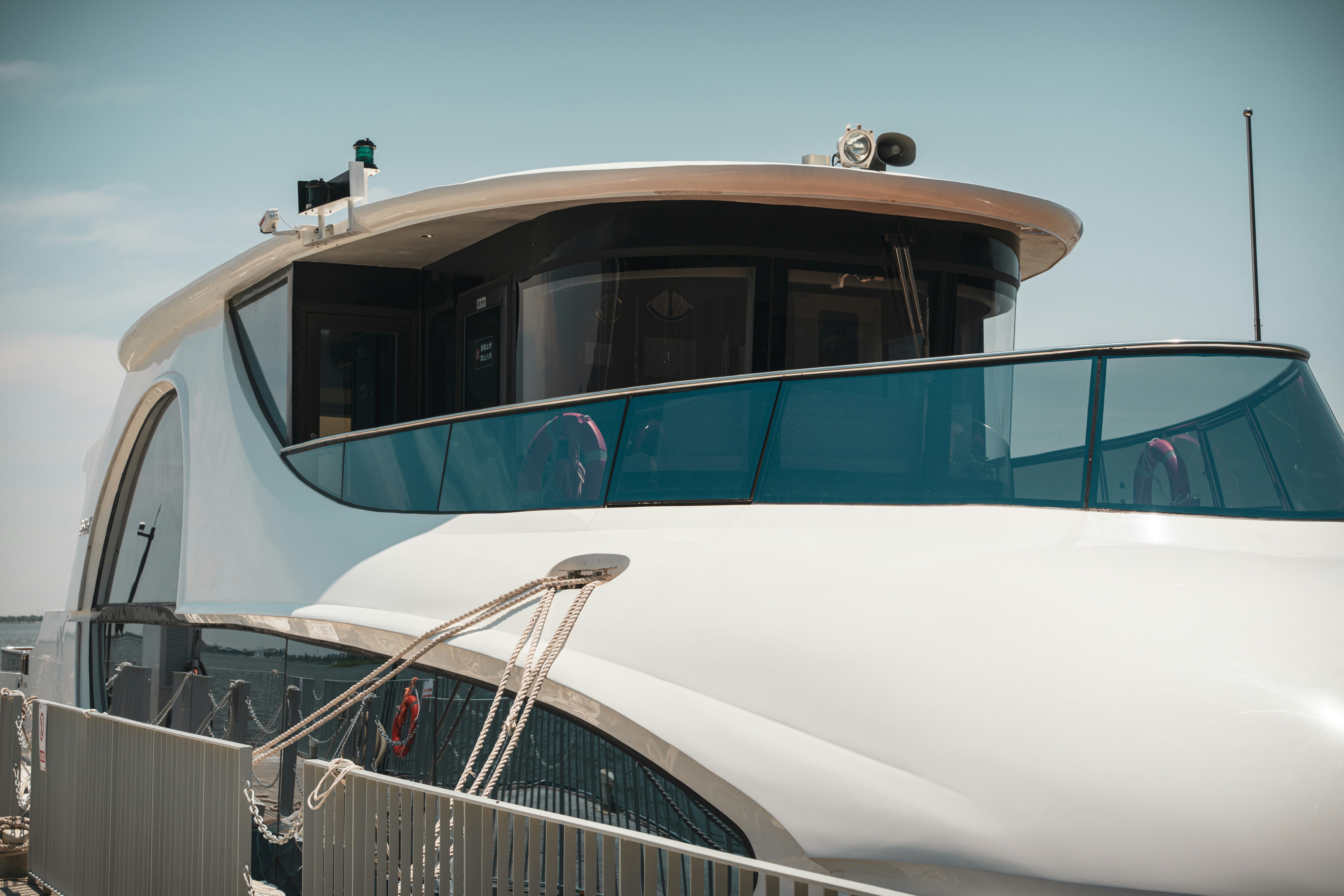 A luxurious white boat rests at the dock.