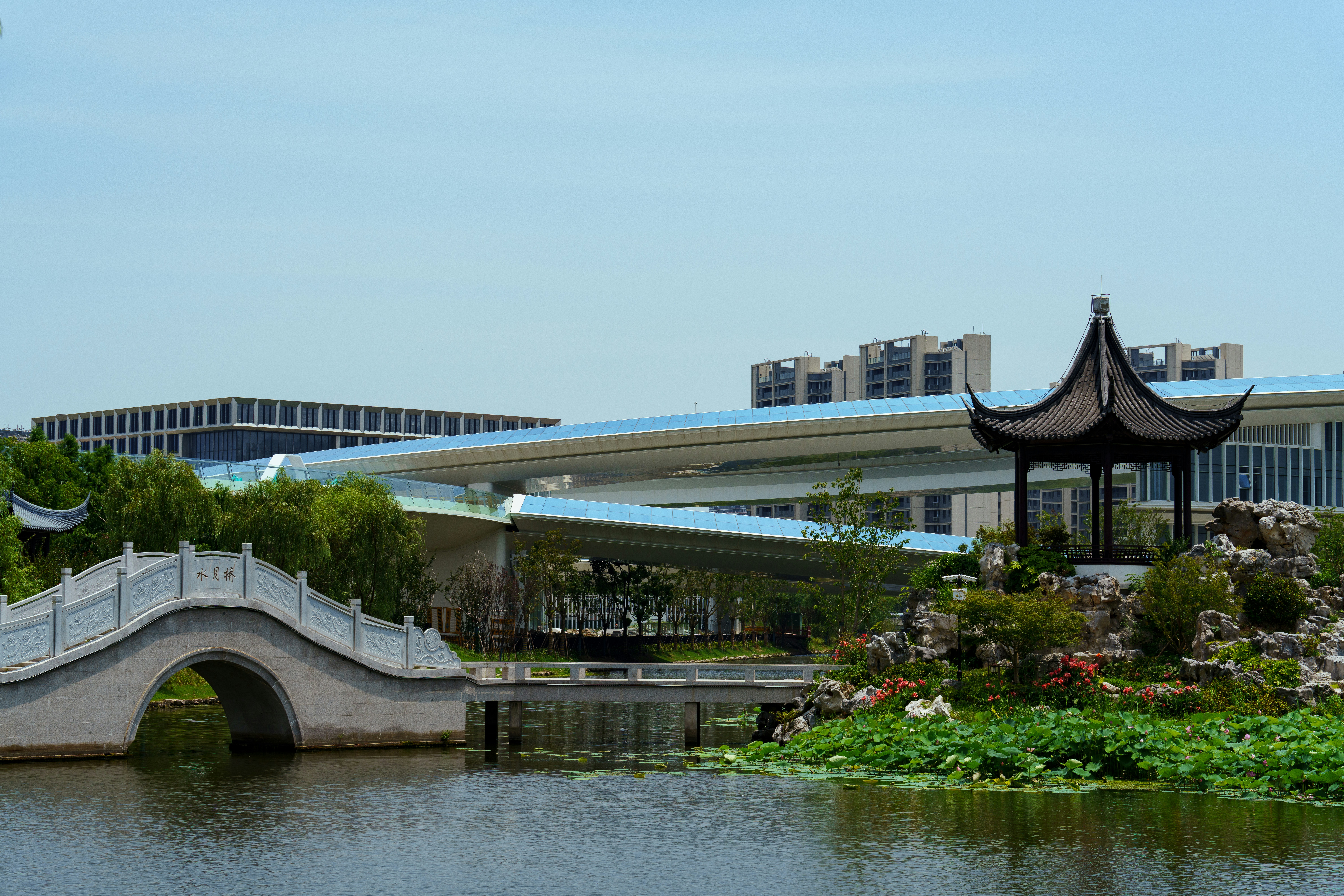 A tranquil landscape with a pagoda and bridge.