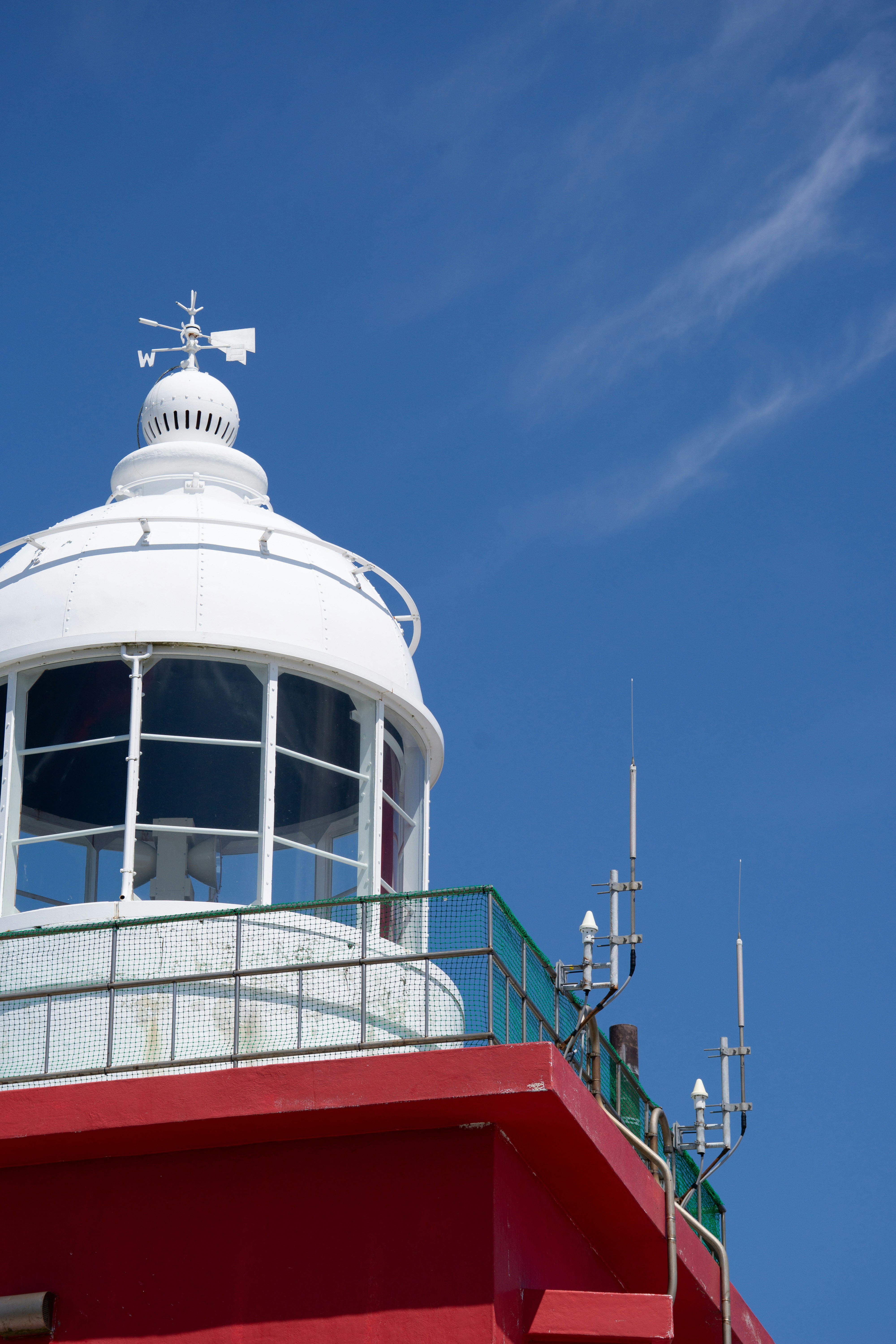 A lighthouse against a clear blue sky.
