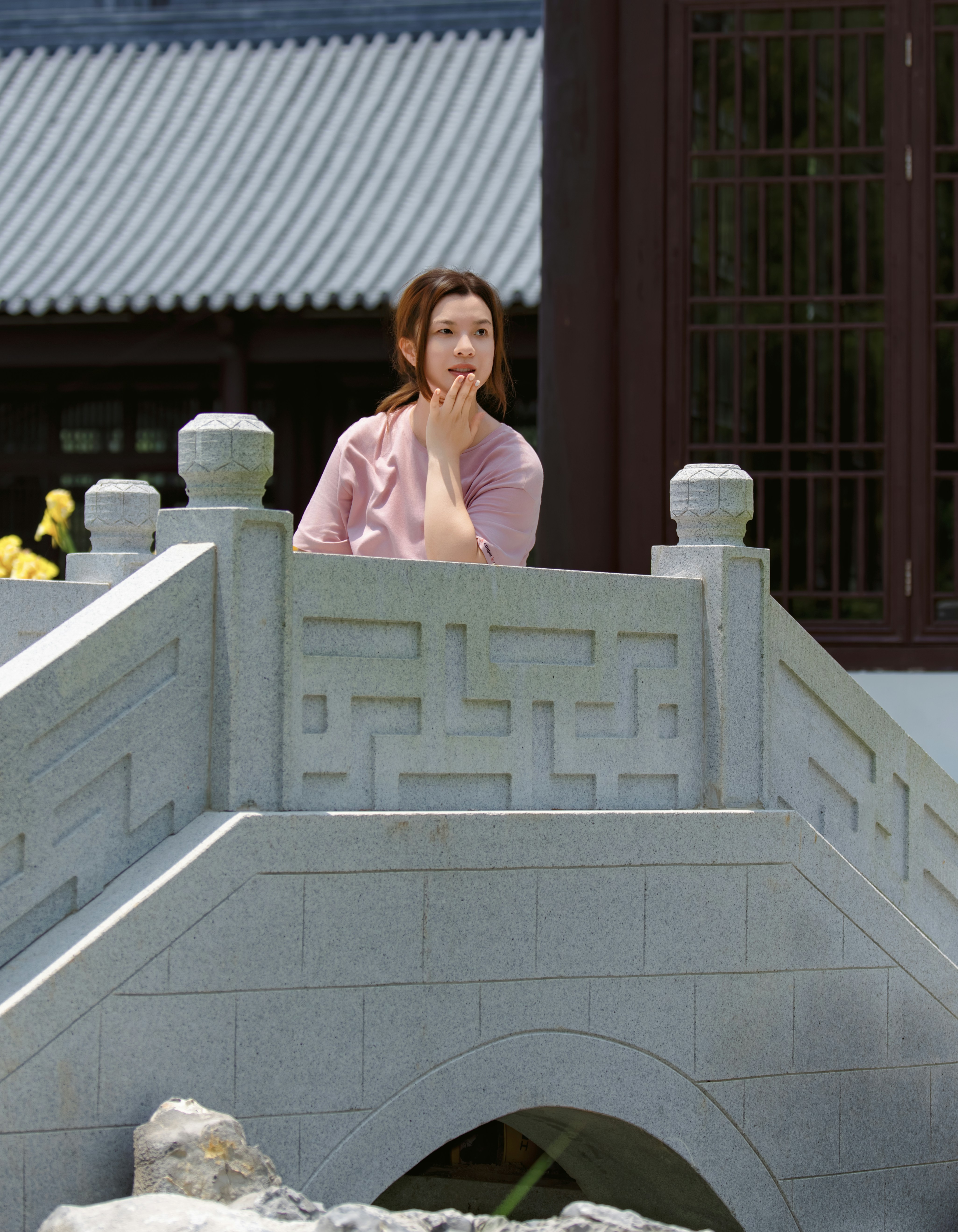 Contemplative Portrait on a Carved Temple Bridge