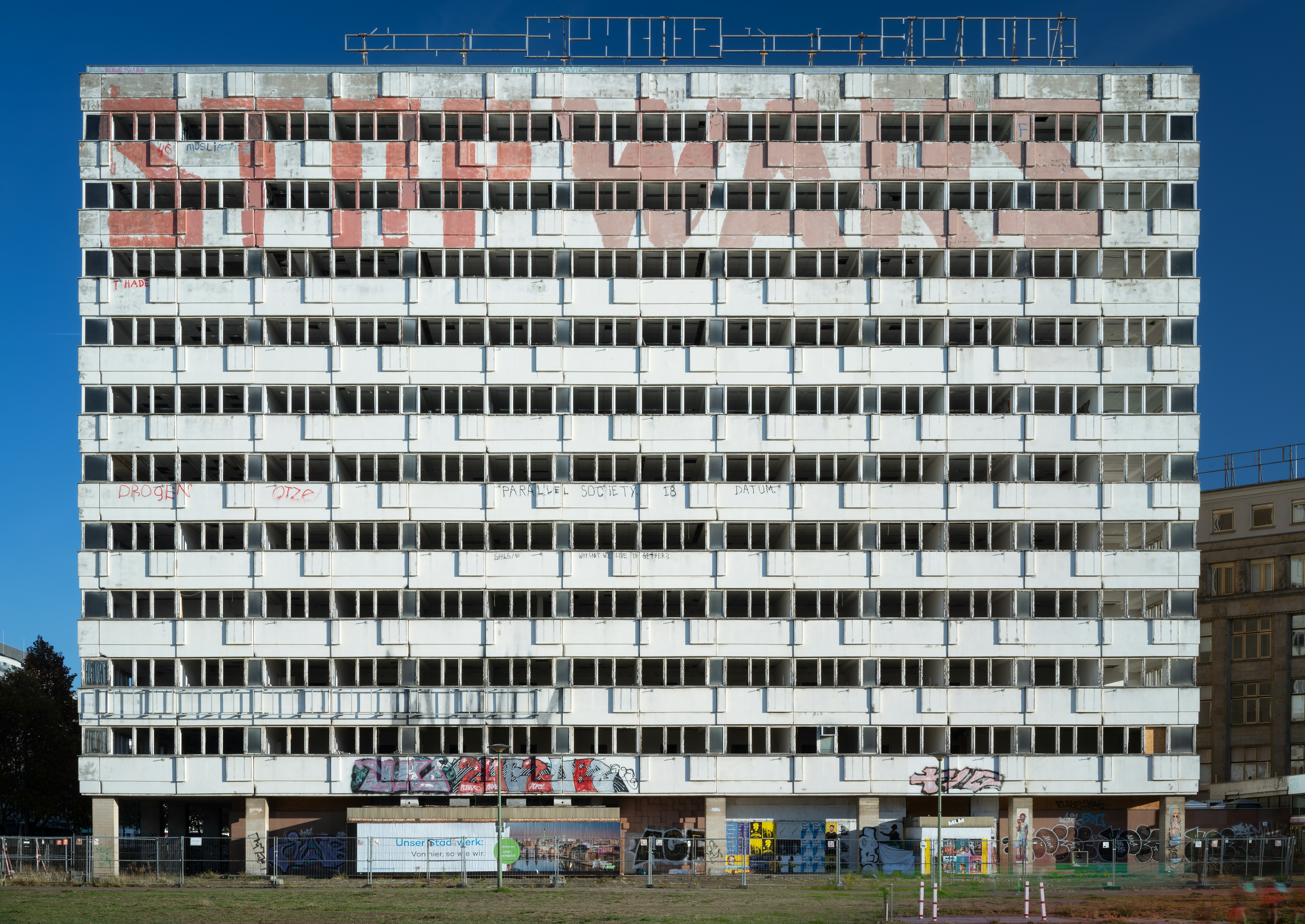 “Stop Wars” / Haus der Statistik Otto-Braun-Strasse in Berlin, dormant in 2018 | Abandoned building with peeling paint.
