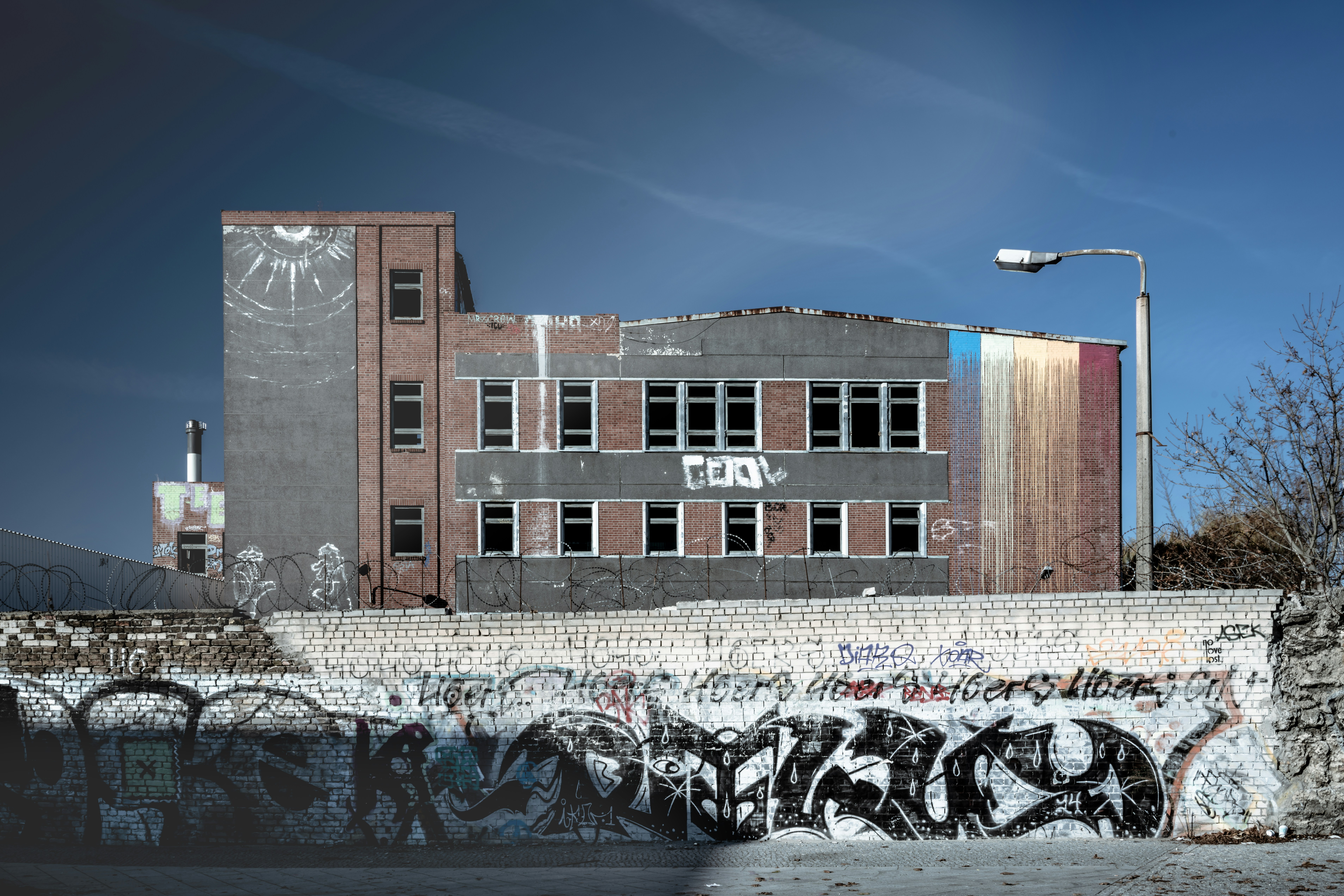 Abandoned building adorned with vibrant graffiti and urban art, showcasing the intersection of decay and creativity.