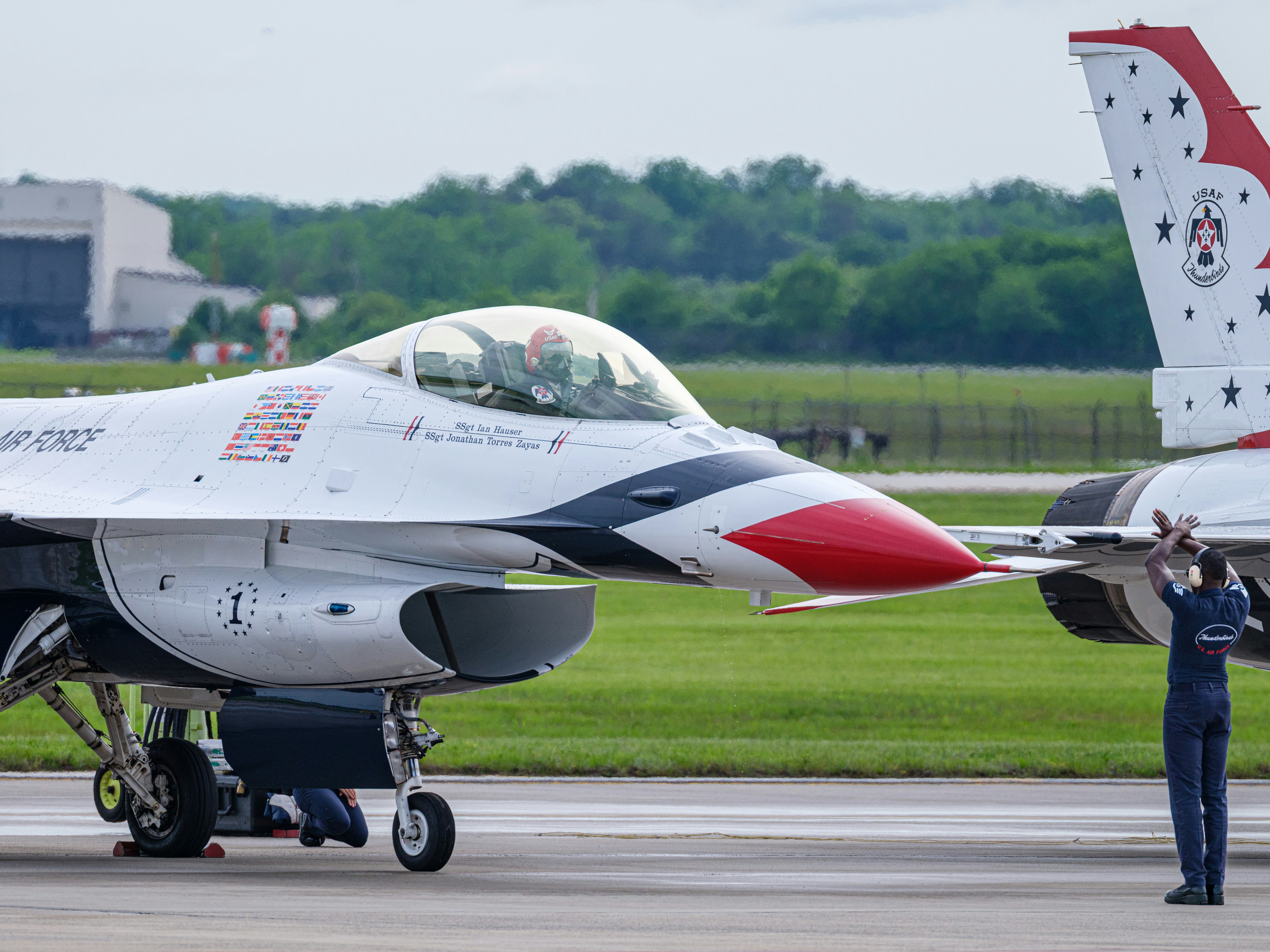 Canopy in Focus: A Demonstration Jet Posed on the Taxiway with Ground Crew