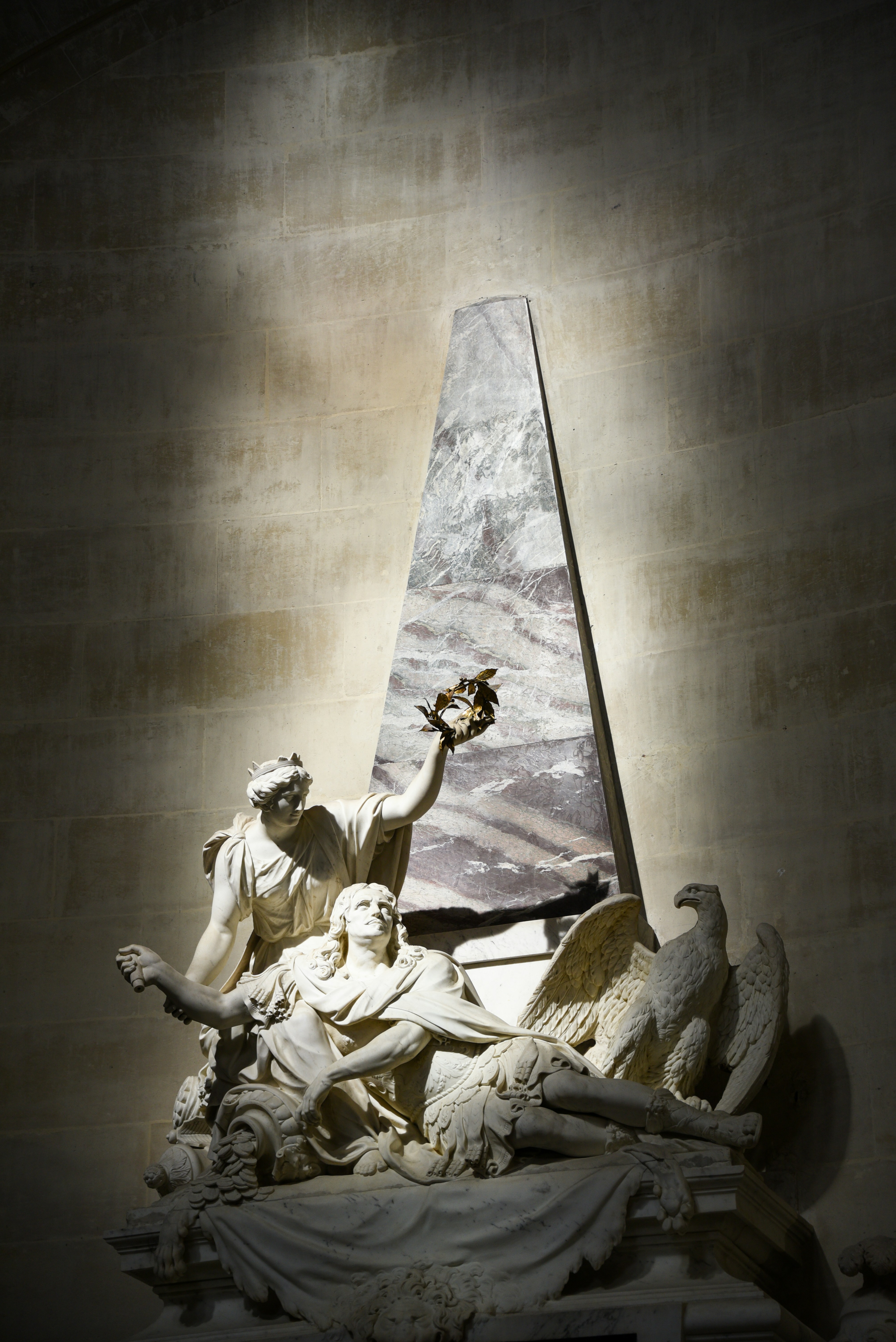 A dramatic marble statue with an obelisk.