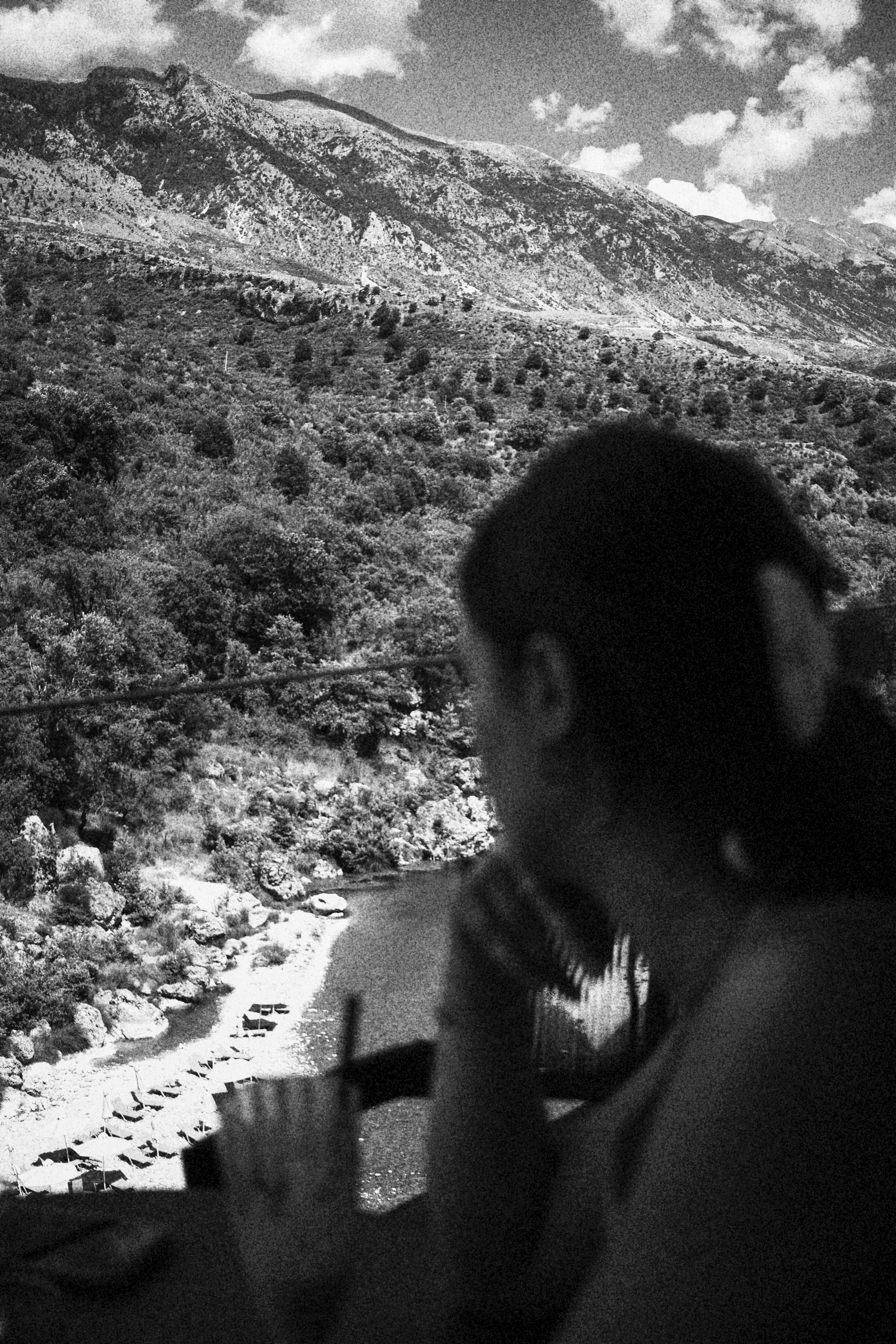 Riverside Reverie: A Quiet Portrait Framed by Mountain Horizons