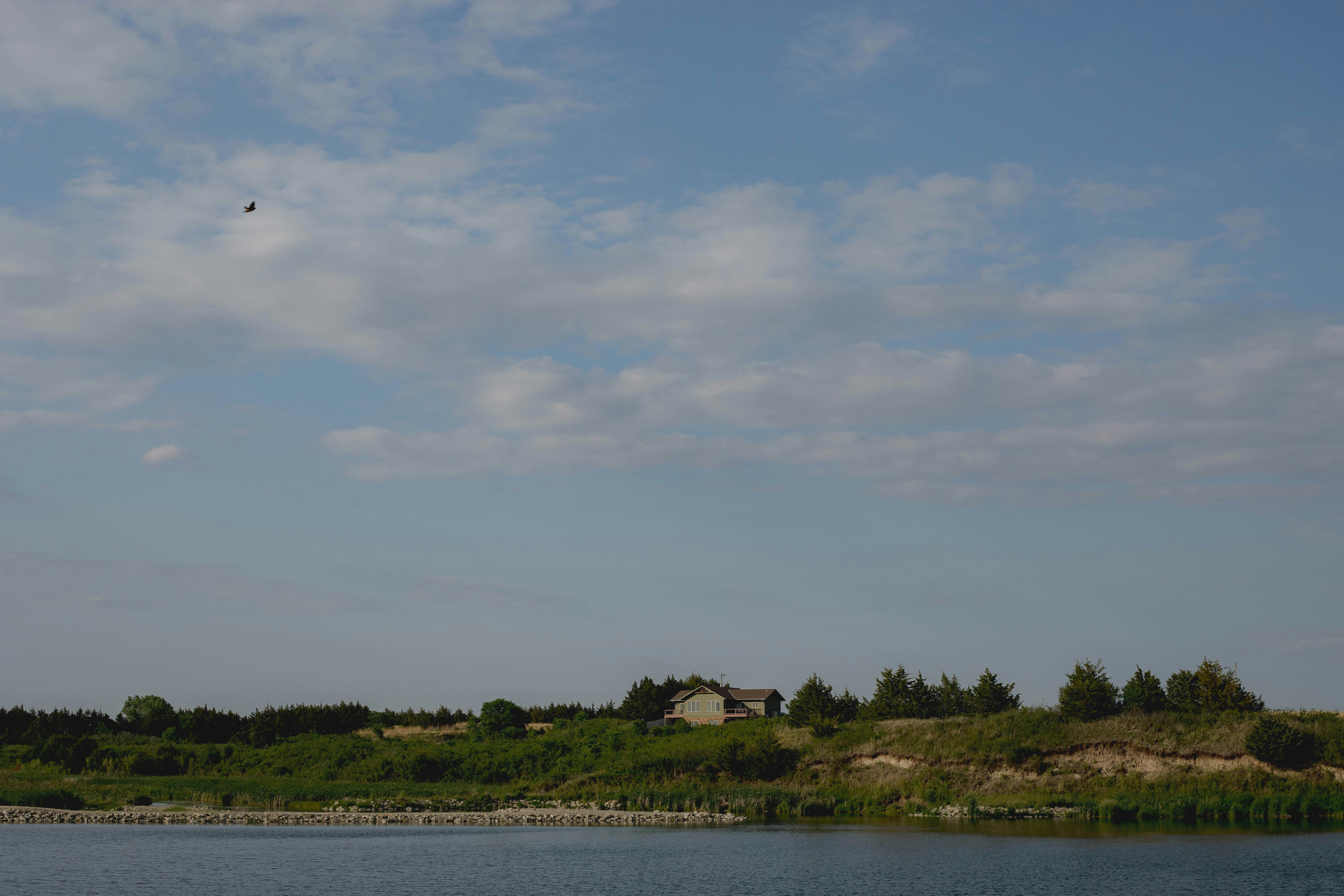 cabin scene calamus reservoir | A body of water with a rural scene.