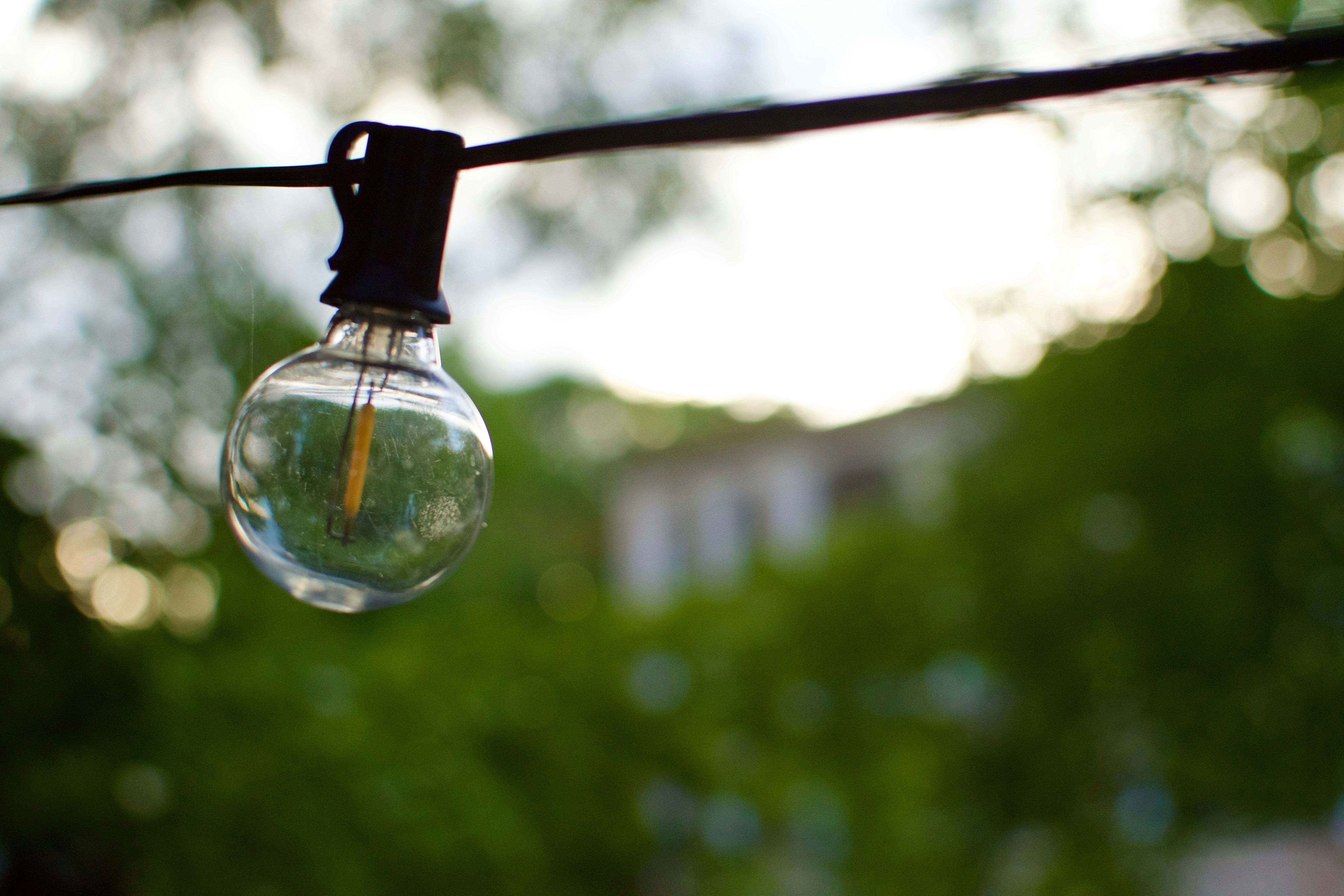 A light in the monastery. | A single lightbulb hangs from a black wire.
