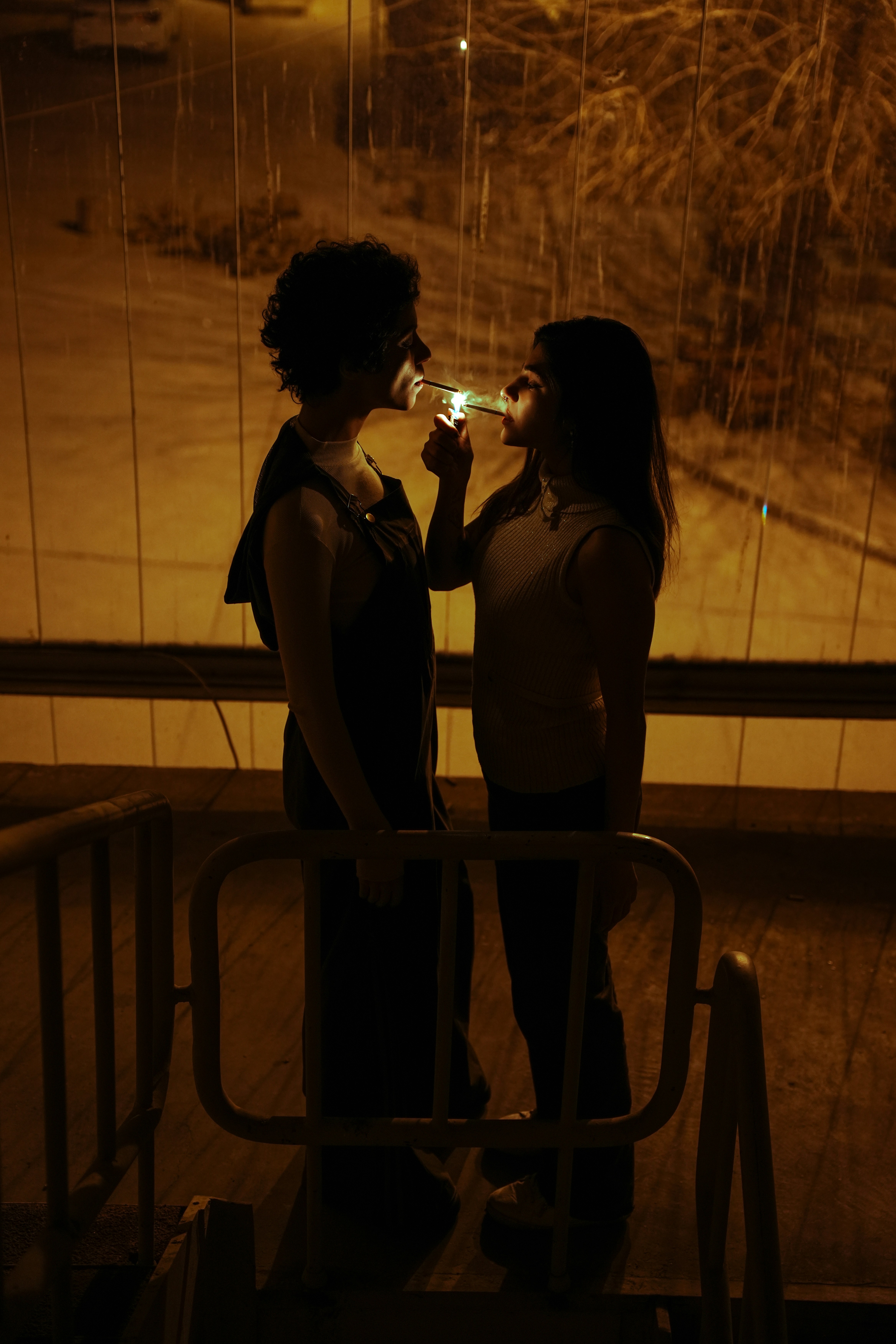 Two people share a light in the snow. photo – Free Woman Image on Unsplash