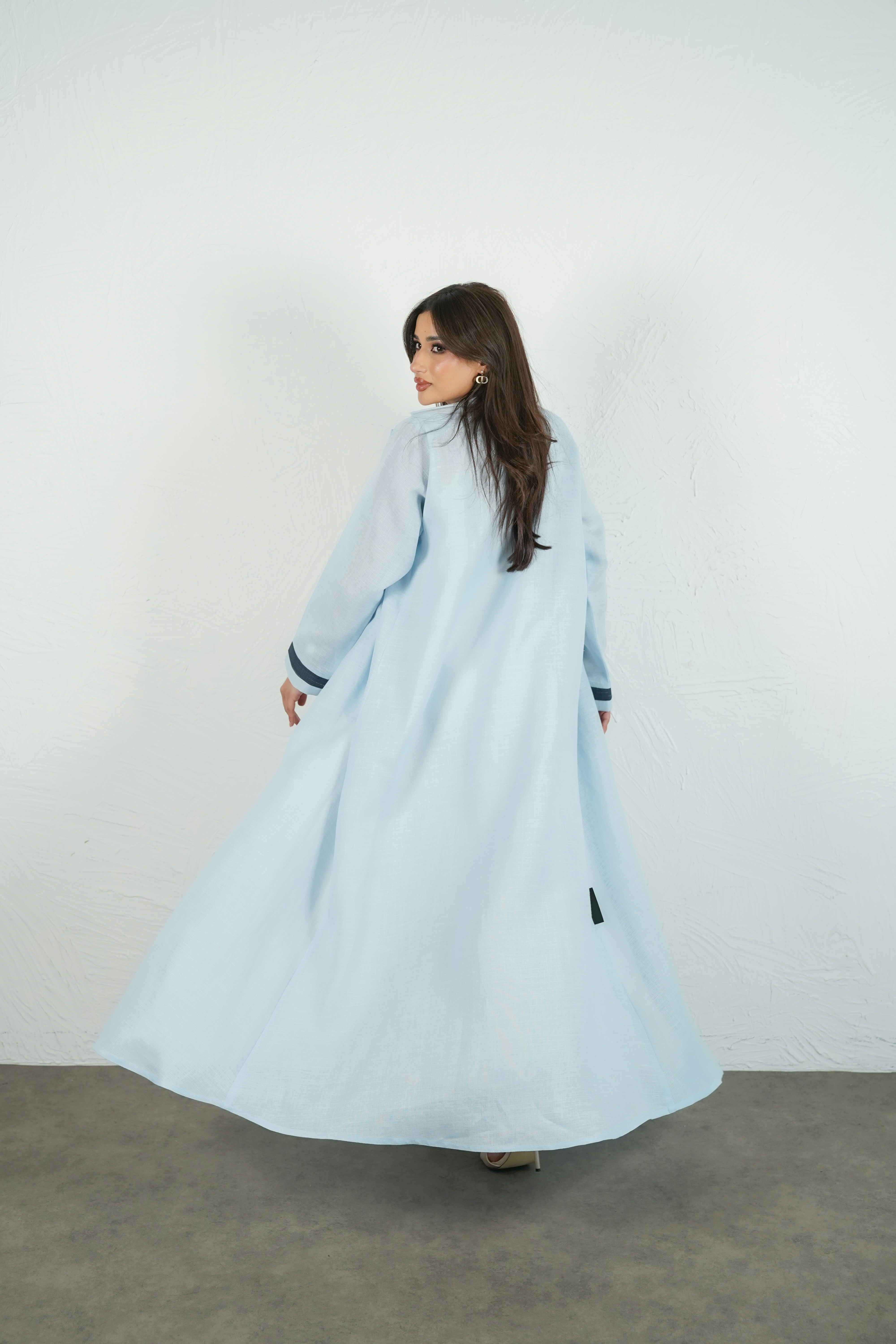 Powder-Blue Coat Spin: A Studio Moment in Motion