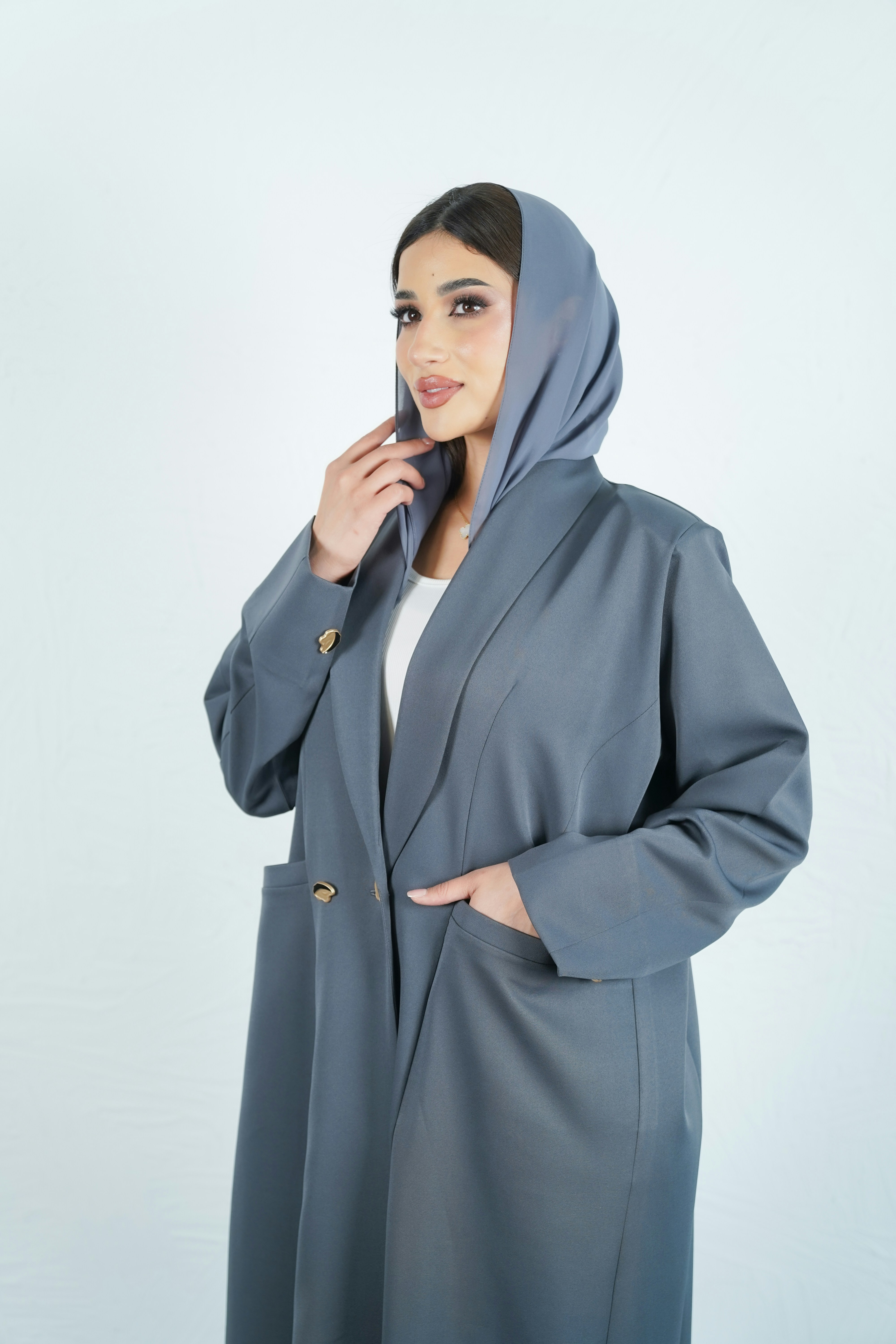 Steel-Blue Confidence: Portrait in a Flowing Drape Coat
