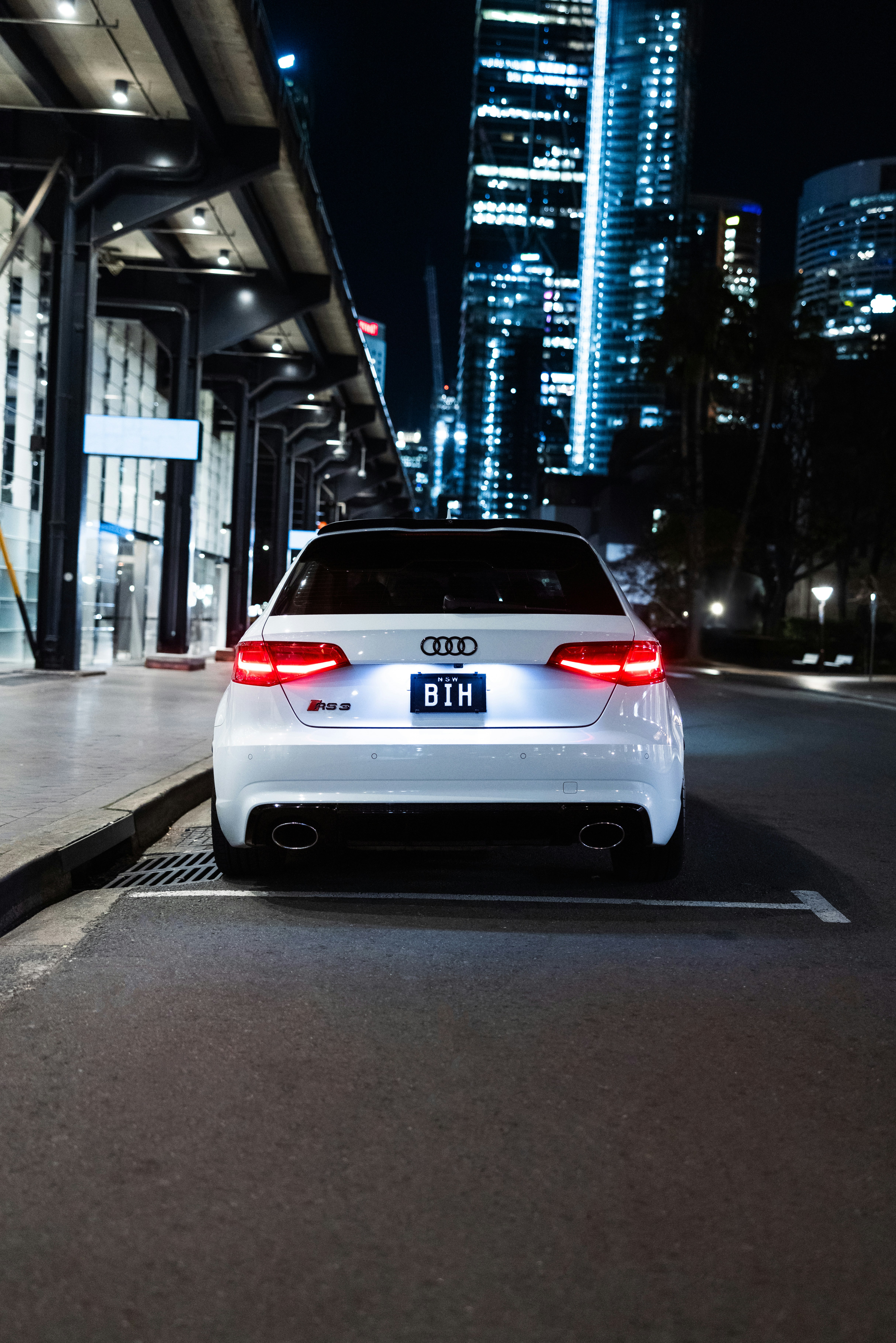 Midnight Neon: White Audi RS5 Beneath a Glassy Skyline