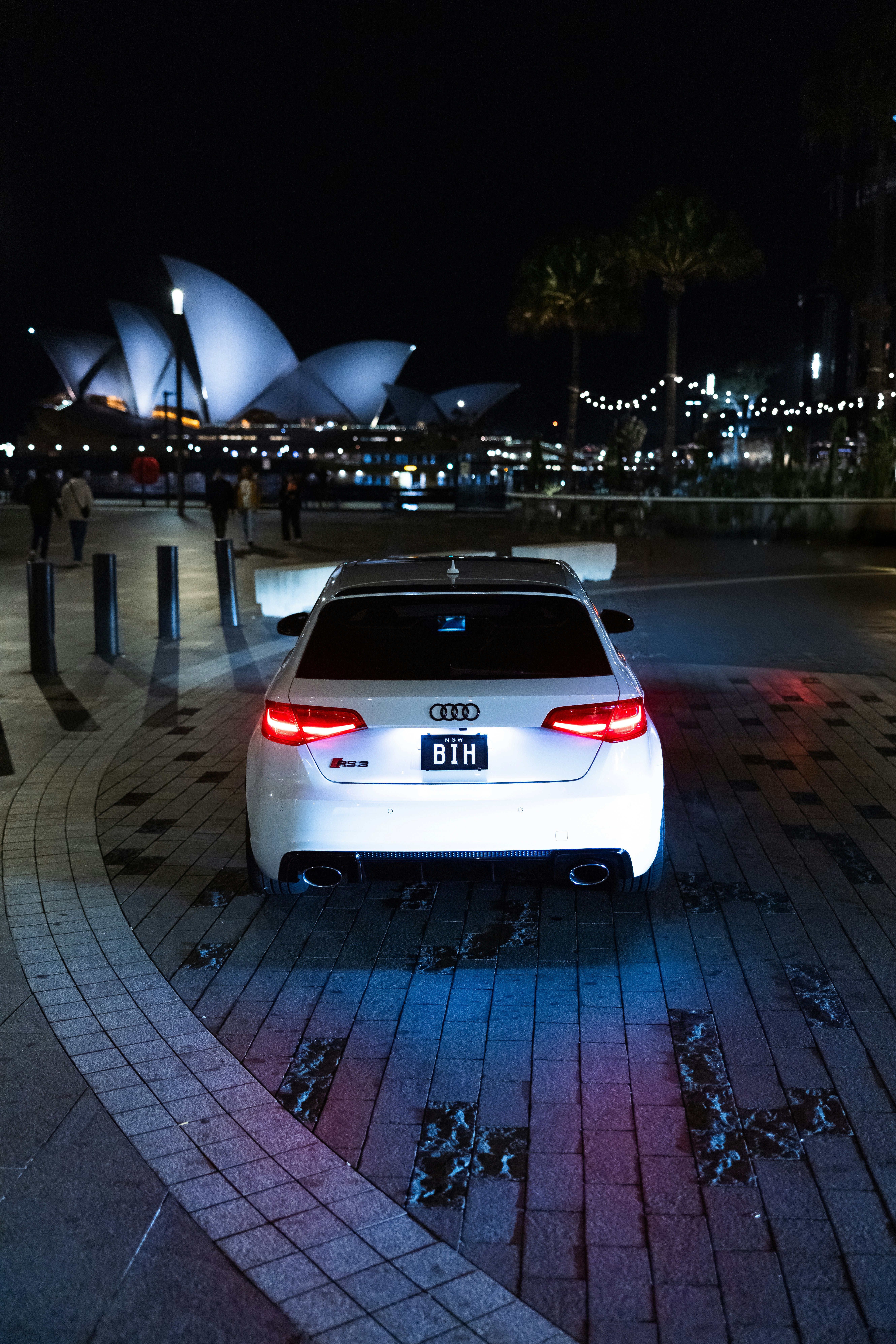 Audi RS3 8V Sportback Quattro - Nightlife in Sydney, Australia - Phone Wallpaper | An audi rs3 parked in front of the opera house.