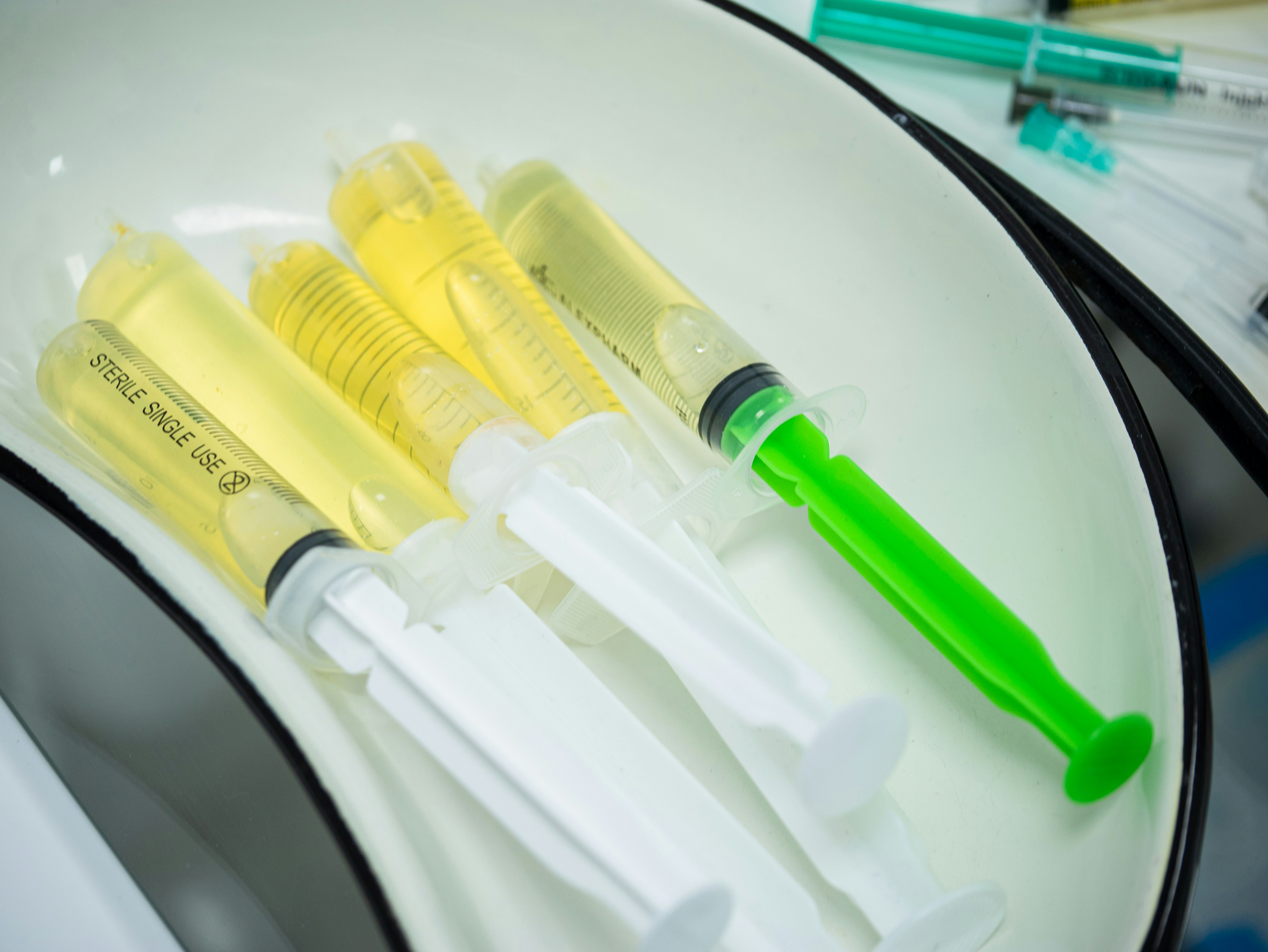 Syringes filled with yellow liquid ready for use.