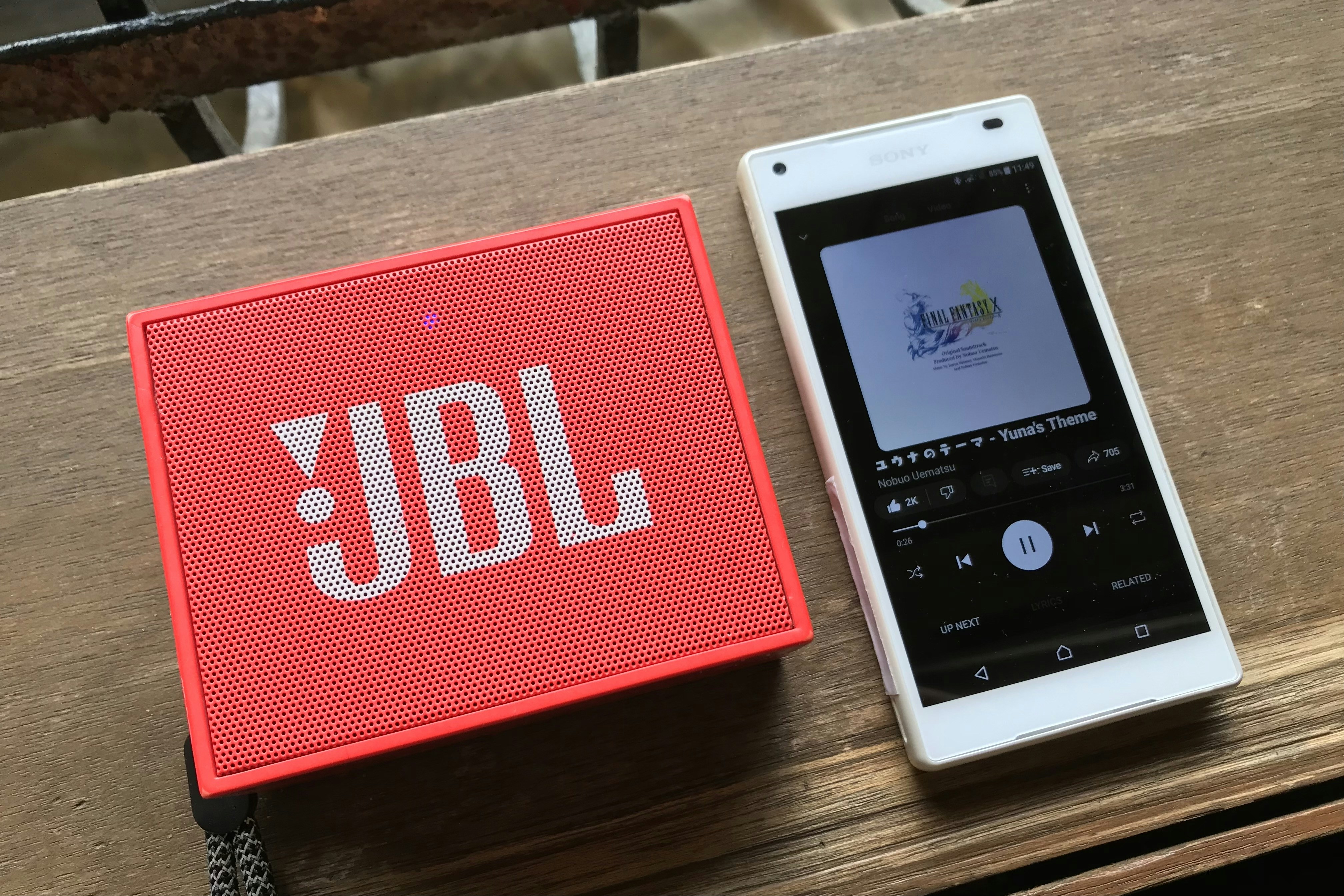 Jbl speaker and phone playing music.