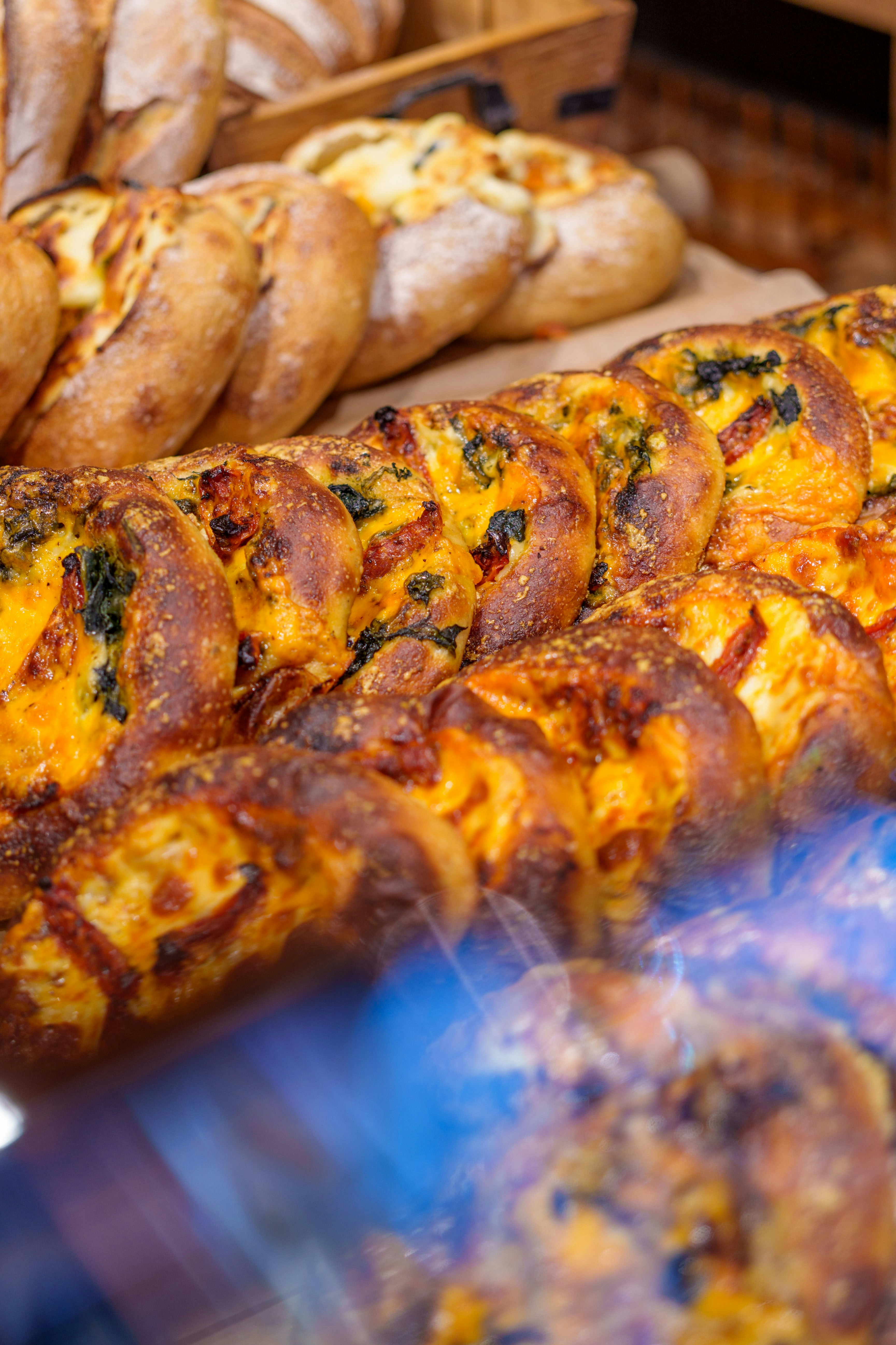 Freshly baked savory pastries arranged enticingly, showcasing golden crusts and vibrant fillings. Perfect for a culinary showcase.