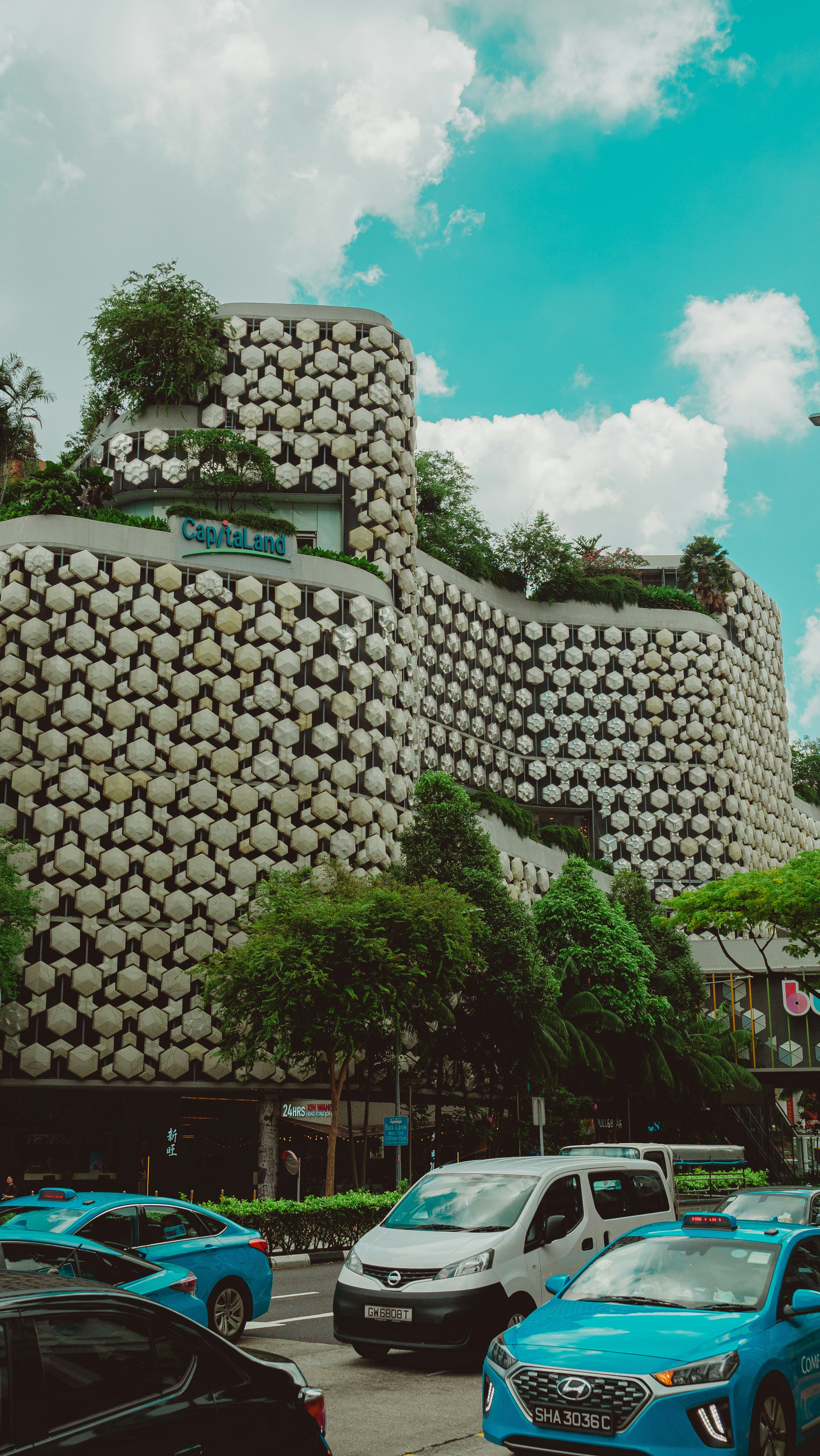 Hexagonal Horizon: CapitaLand’s Honeycomb Tower over a Bustling Street