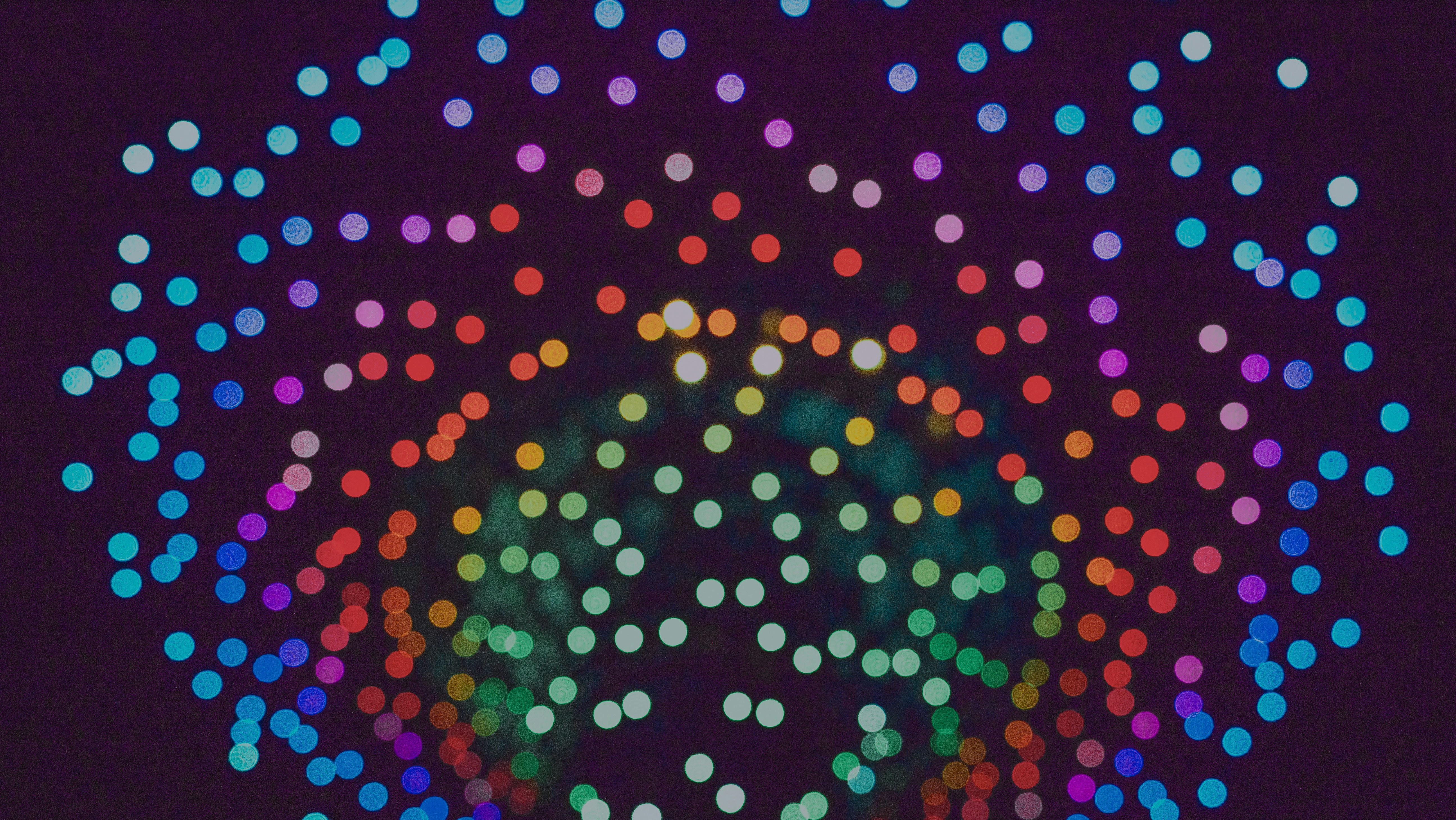 Colorful dots form a semi-circular pattern.