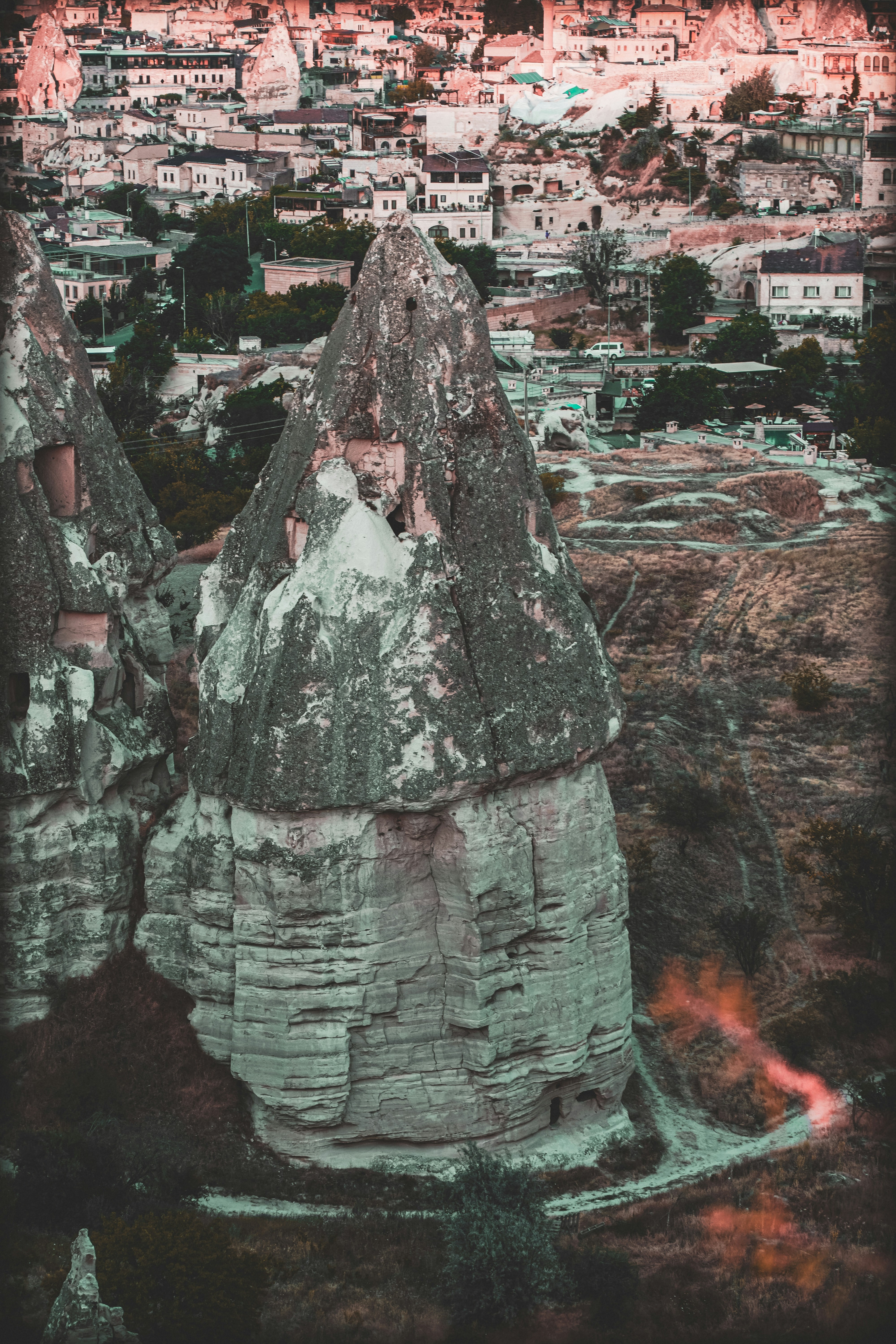 Unique rock formations dominate a city's skyline.