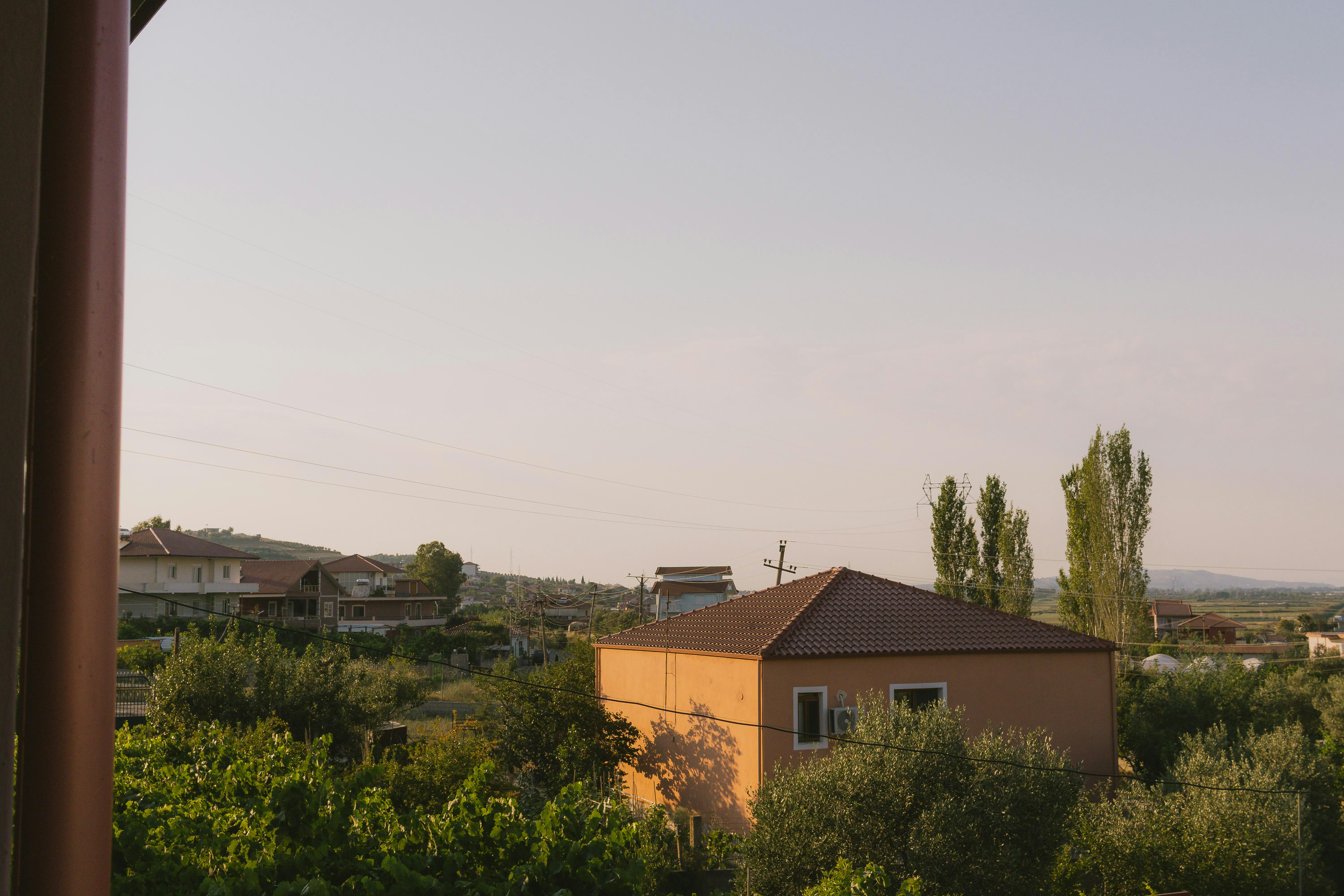 View of houses and trees under a clear sky.