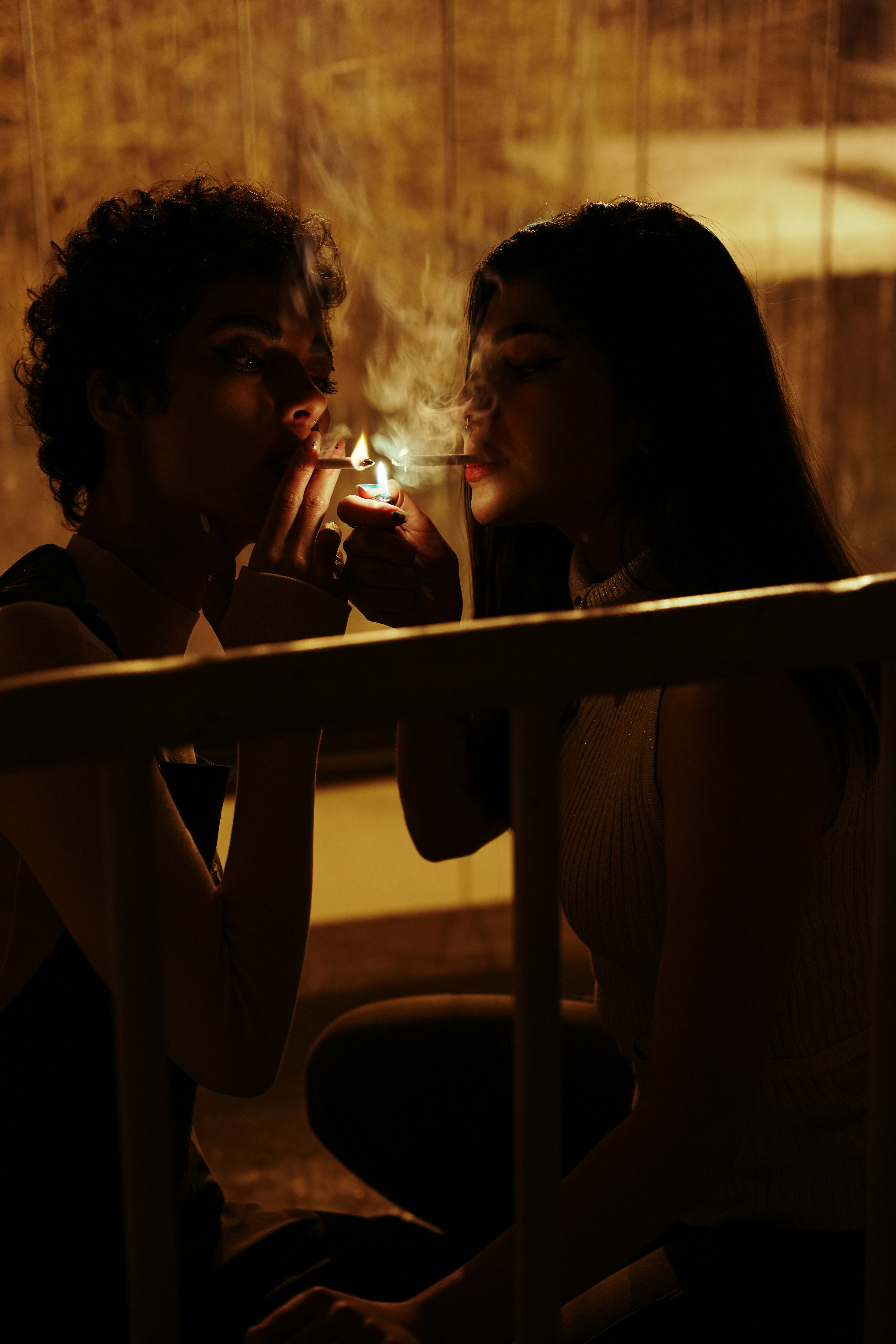 Amber Convergence: A Dimly Lit Moment of Shared Smoke