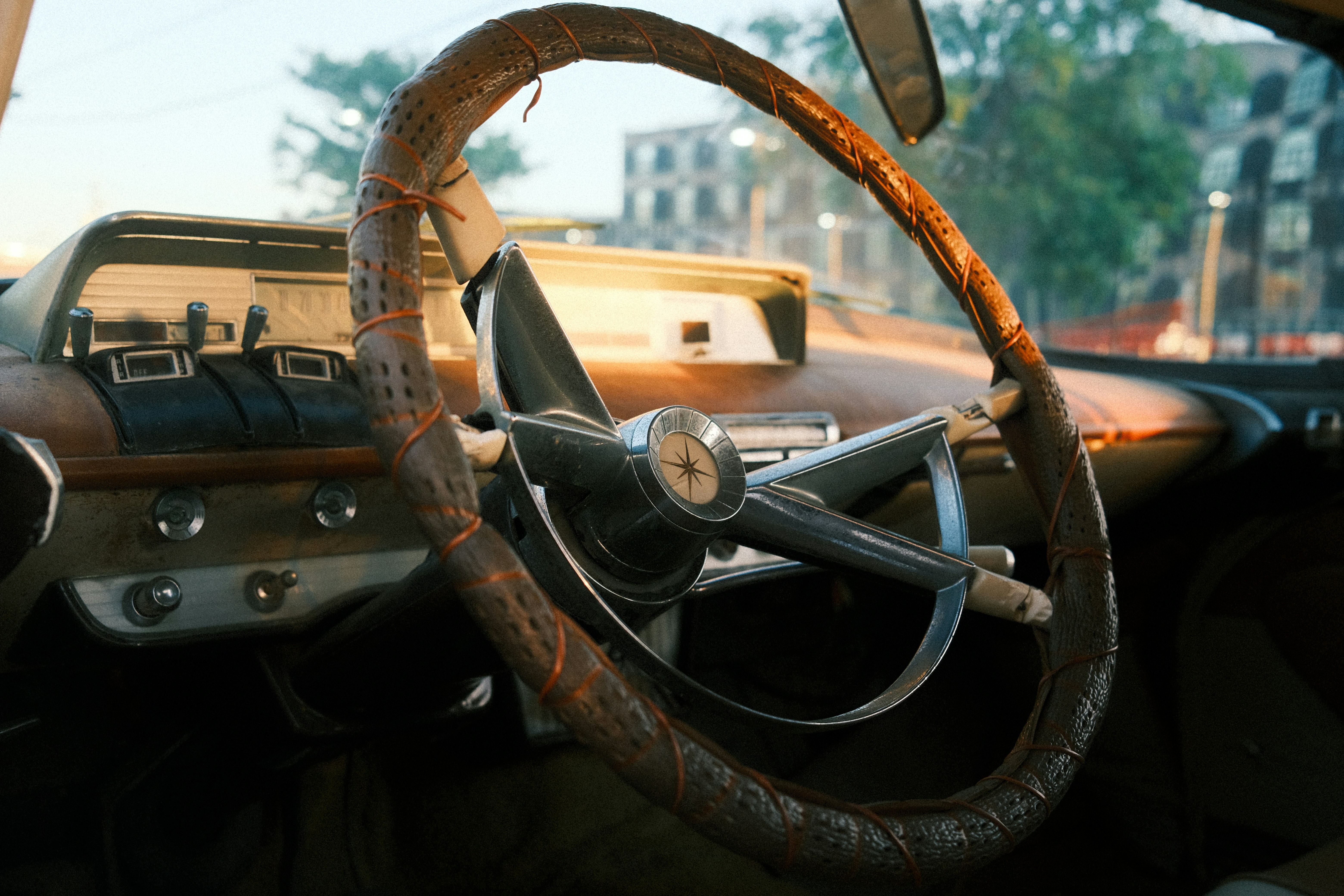 Timeworn Pulse: The Leather-Wrapped Steering Wheel of a Vintage Car
