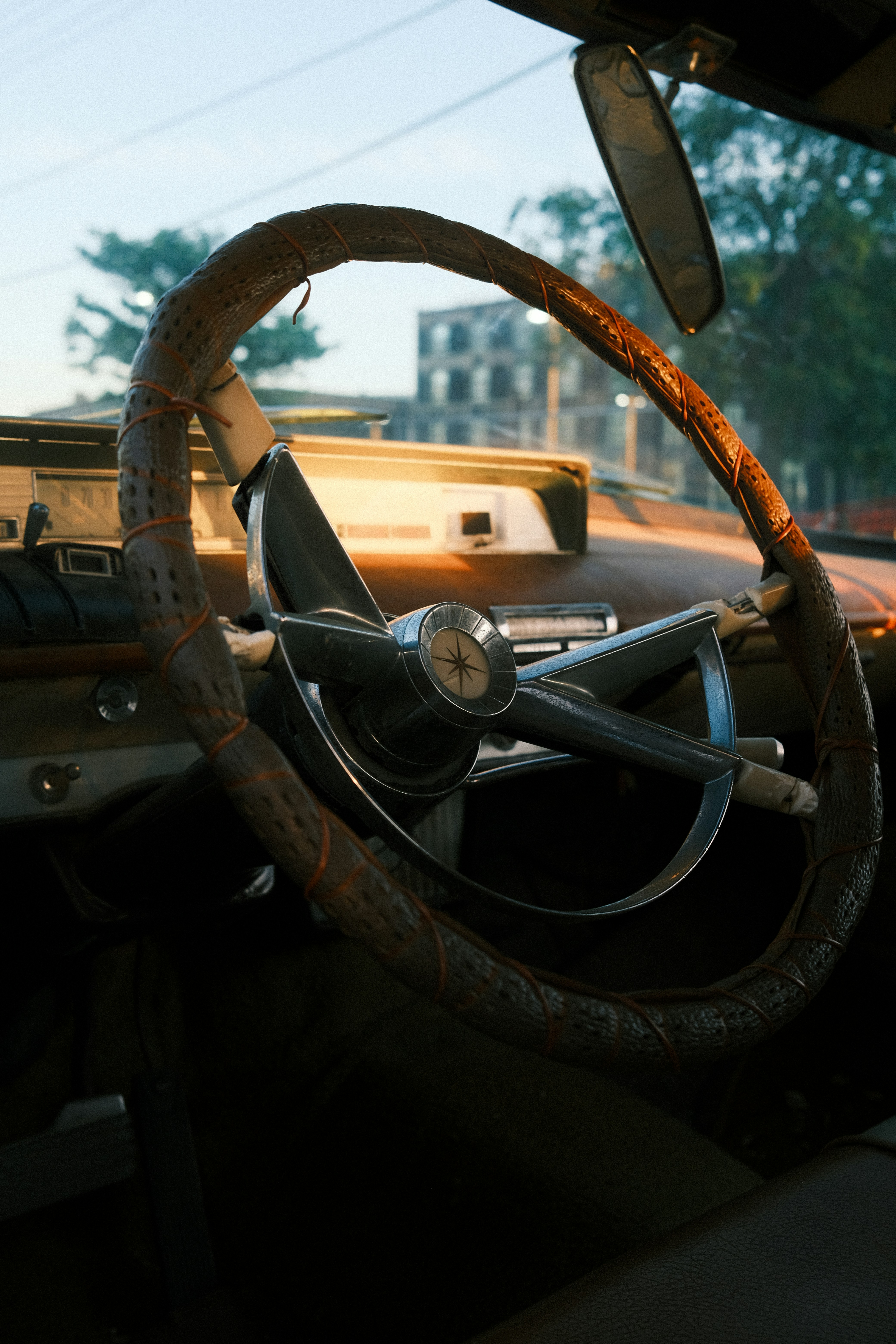 An old car's steering wheel is shown.