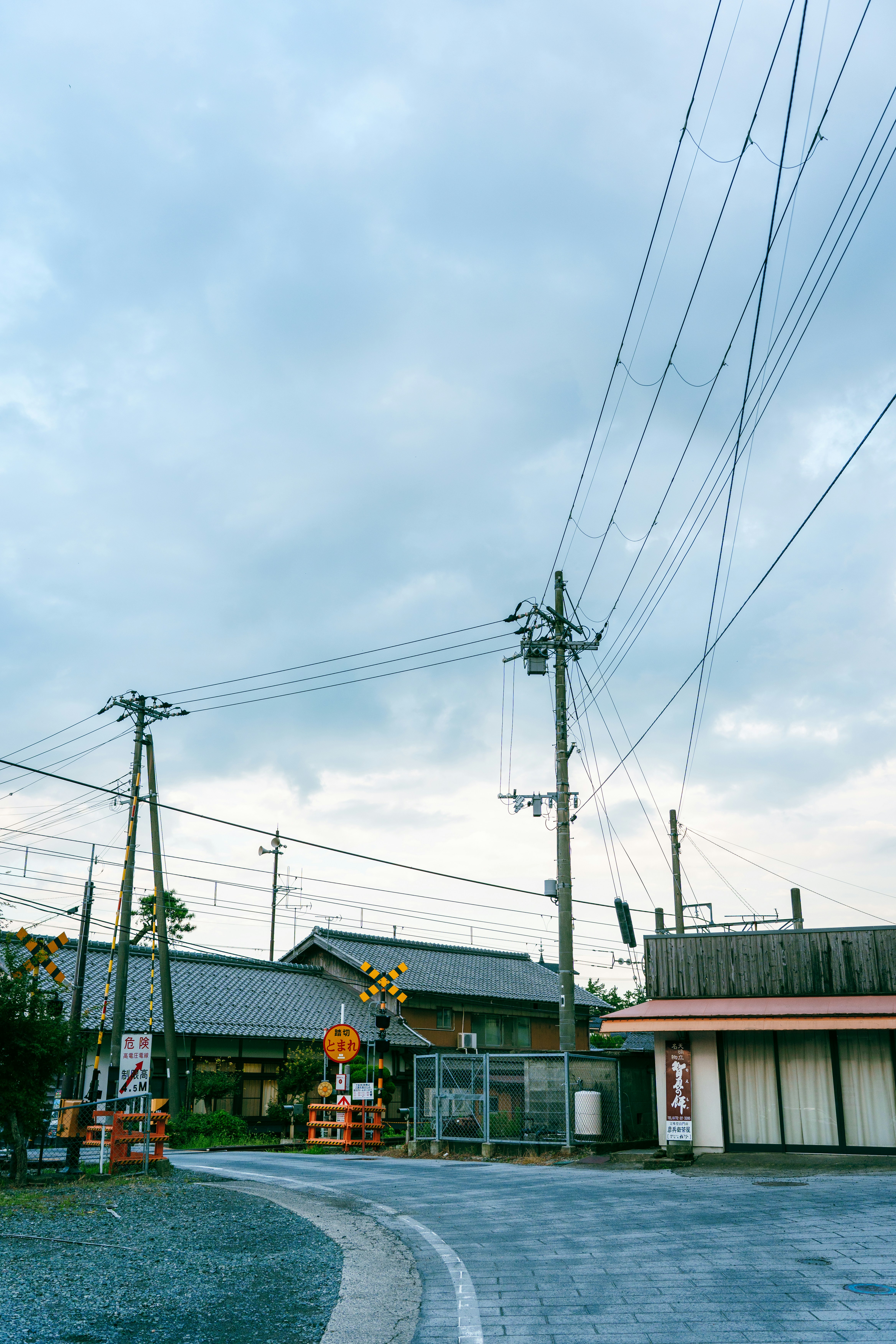 Train tracks and buildings under a cloudy sky.