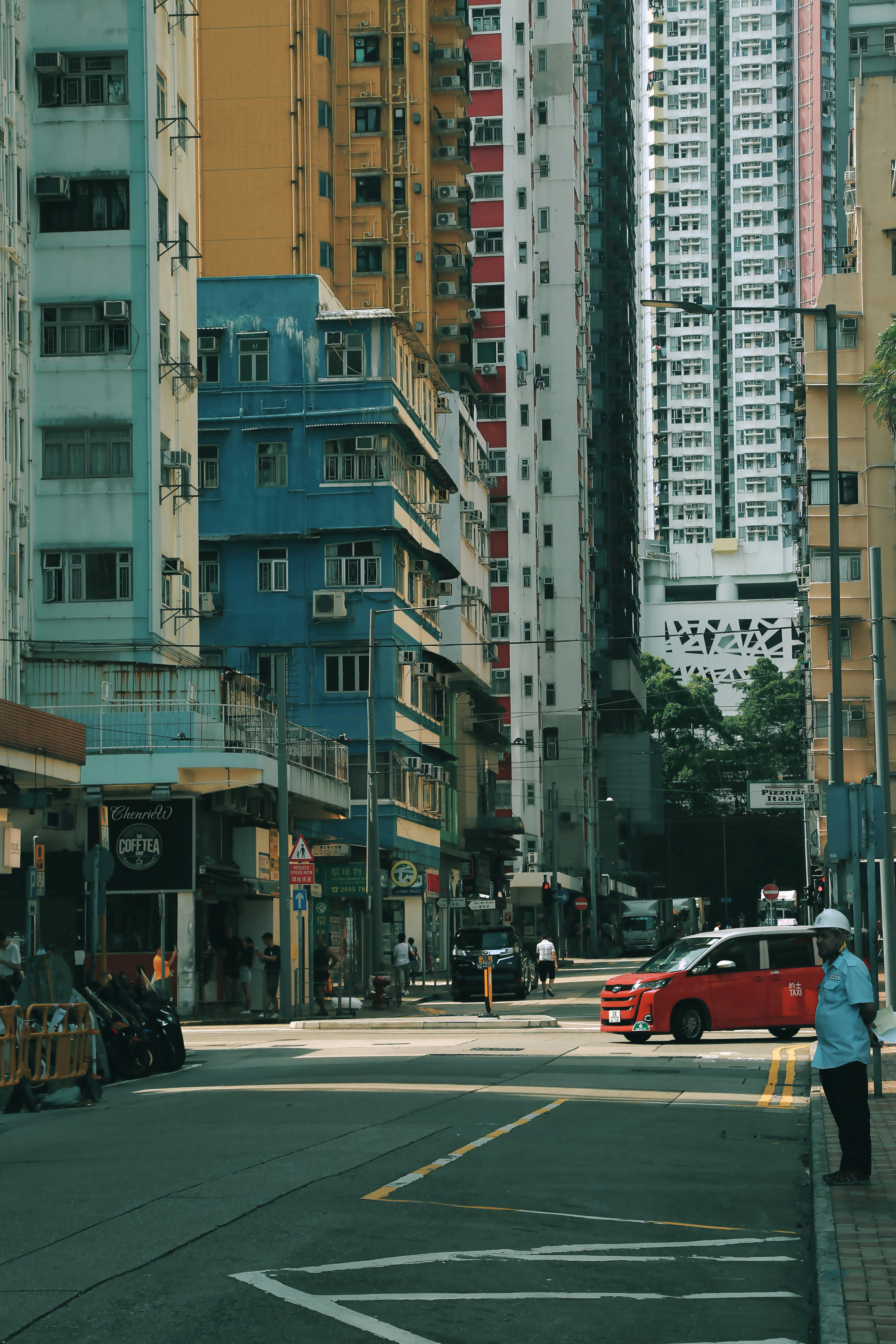 Cityscape with colorful buildings and a red taxi.