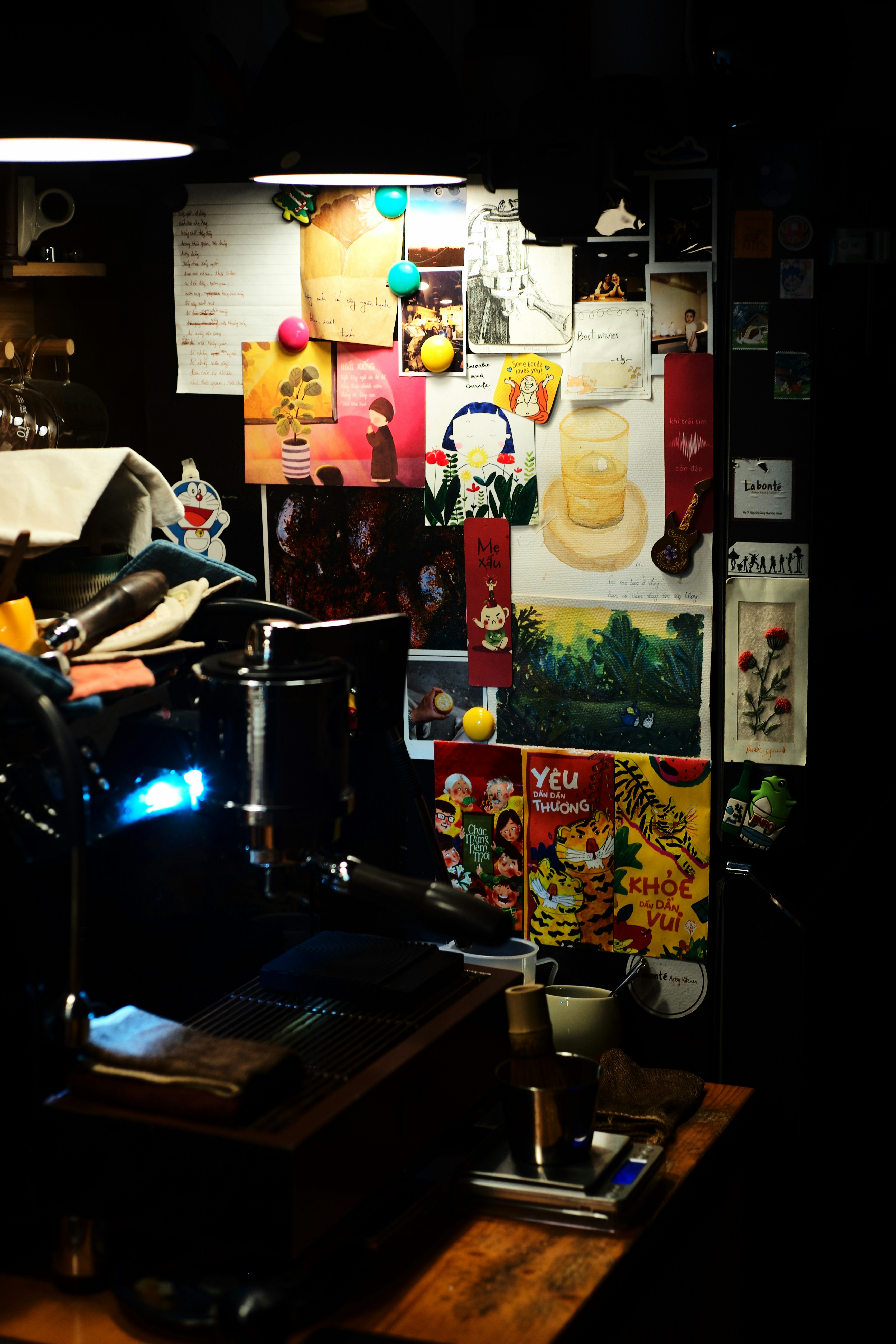 A dark cafe corner with decorations and a coffee machine.