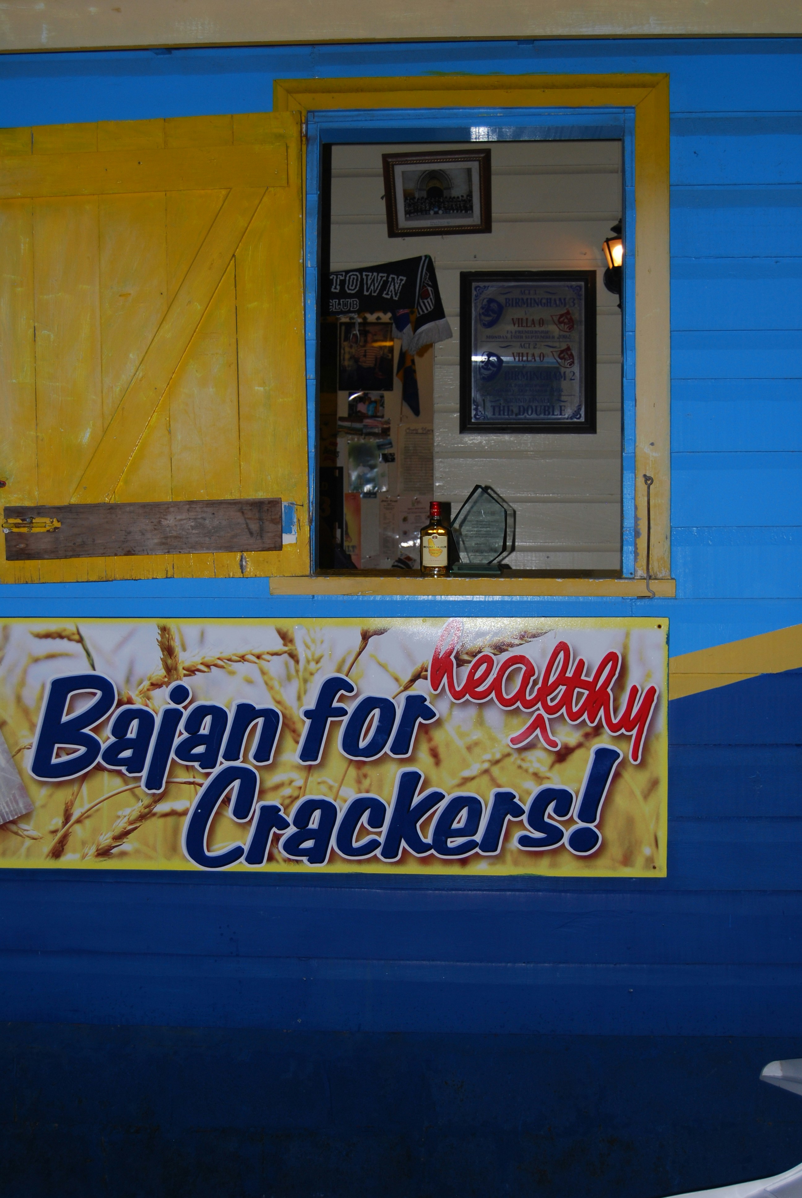 Bright Blue Shack Window: A Coastal Snack Stand with Cracker Banner