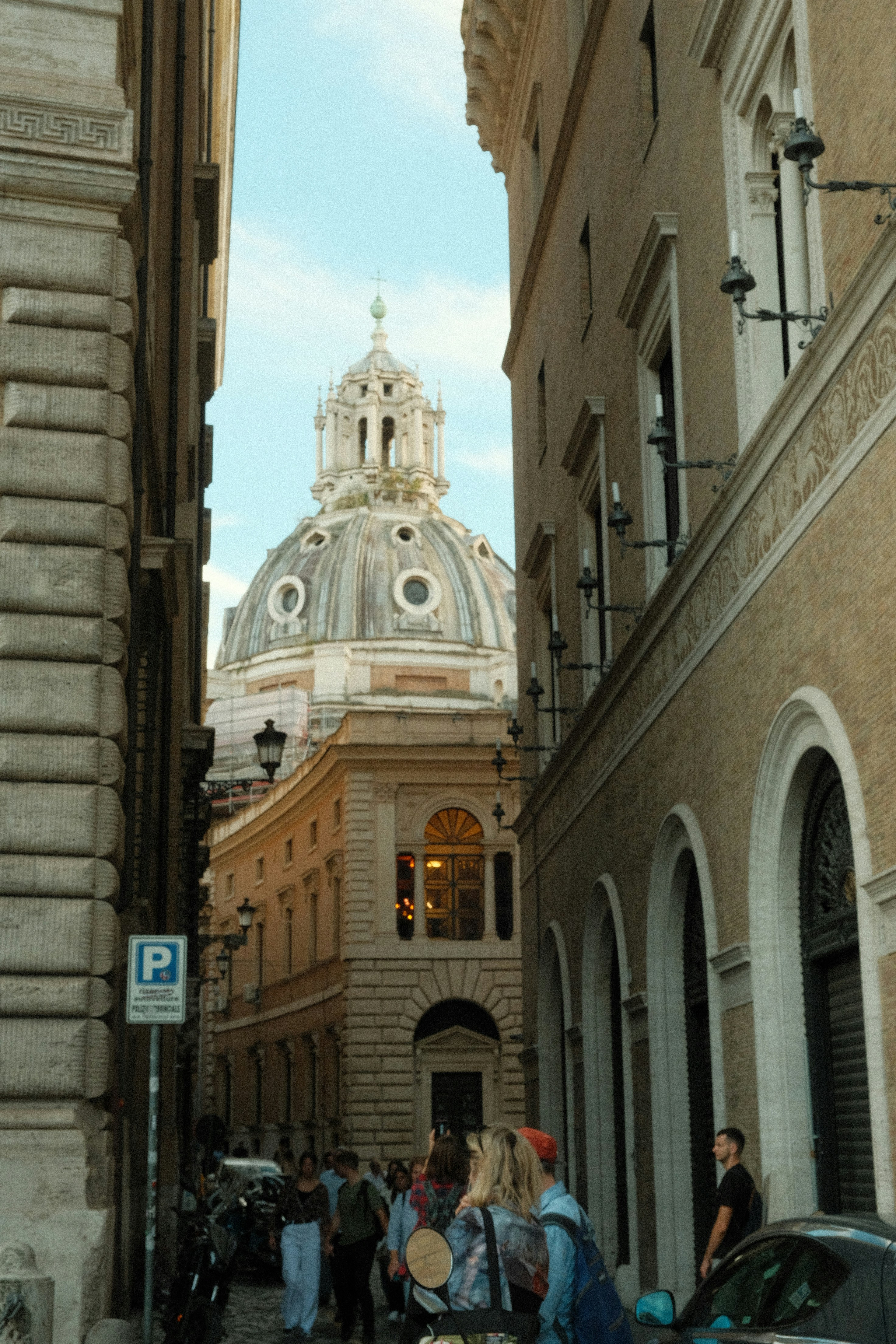 Rome streets | A street in rome leads to a beautiful building.
