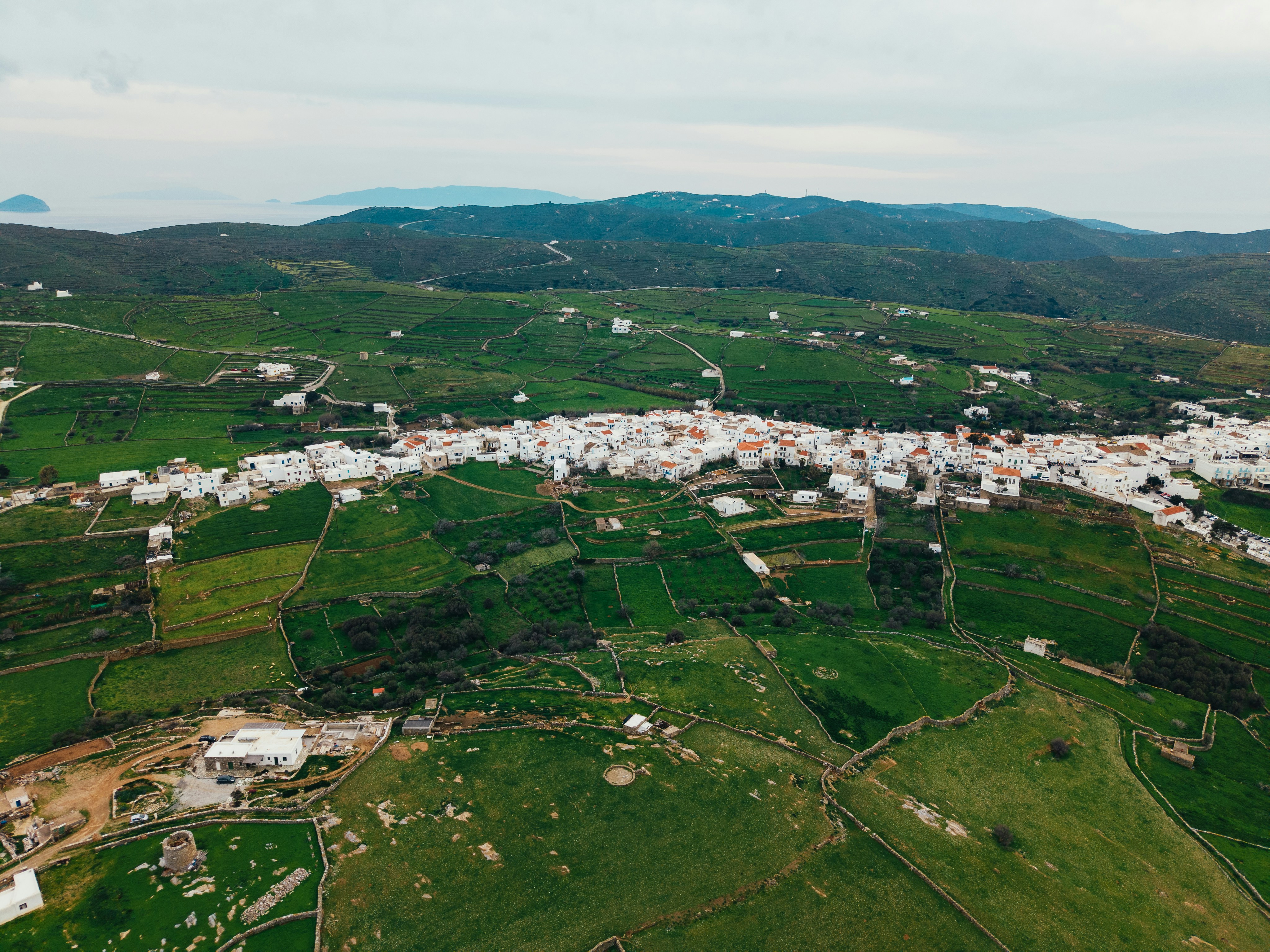 Kythnos Town | Aerial view of a green landscape with a village.