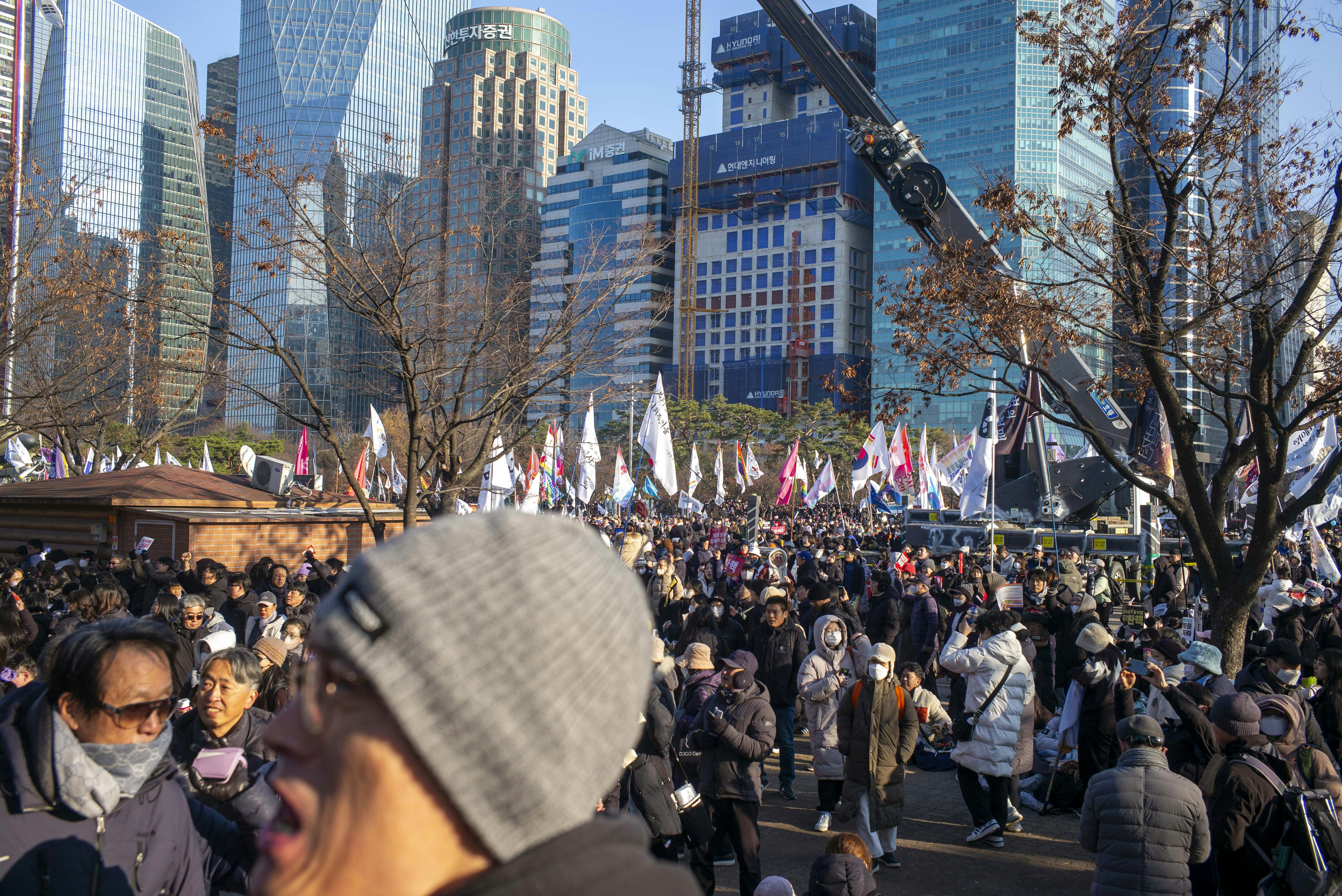 Protest for Yoon's impeachment | Large crowd of people protest in urban environment.