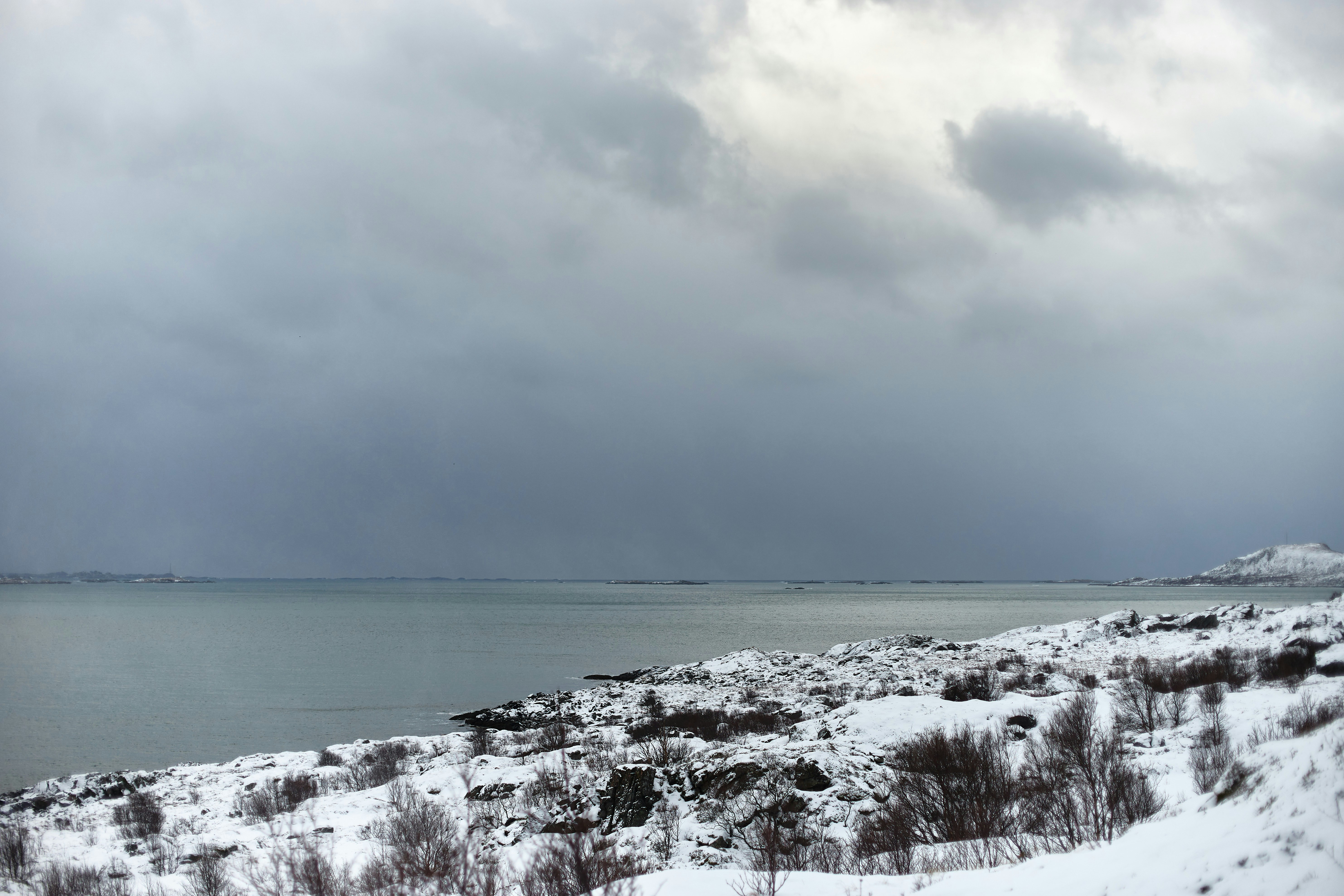 A cold, wintery landscape with cloudy skies.
