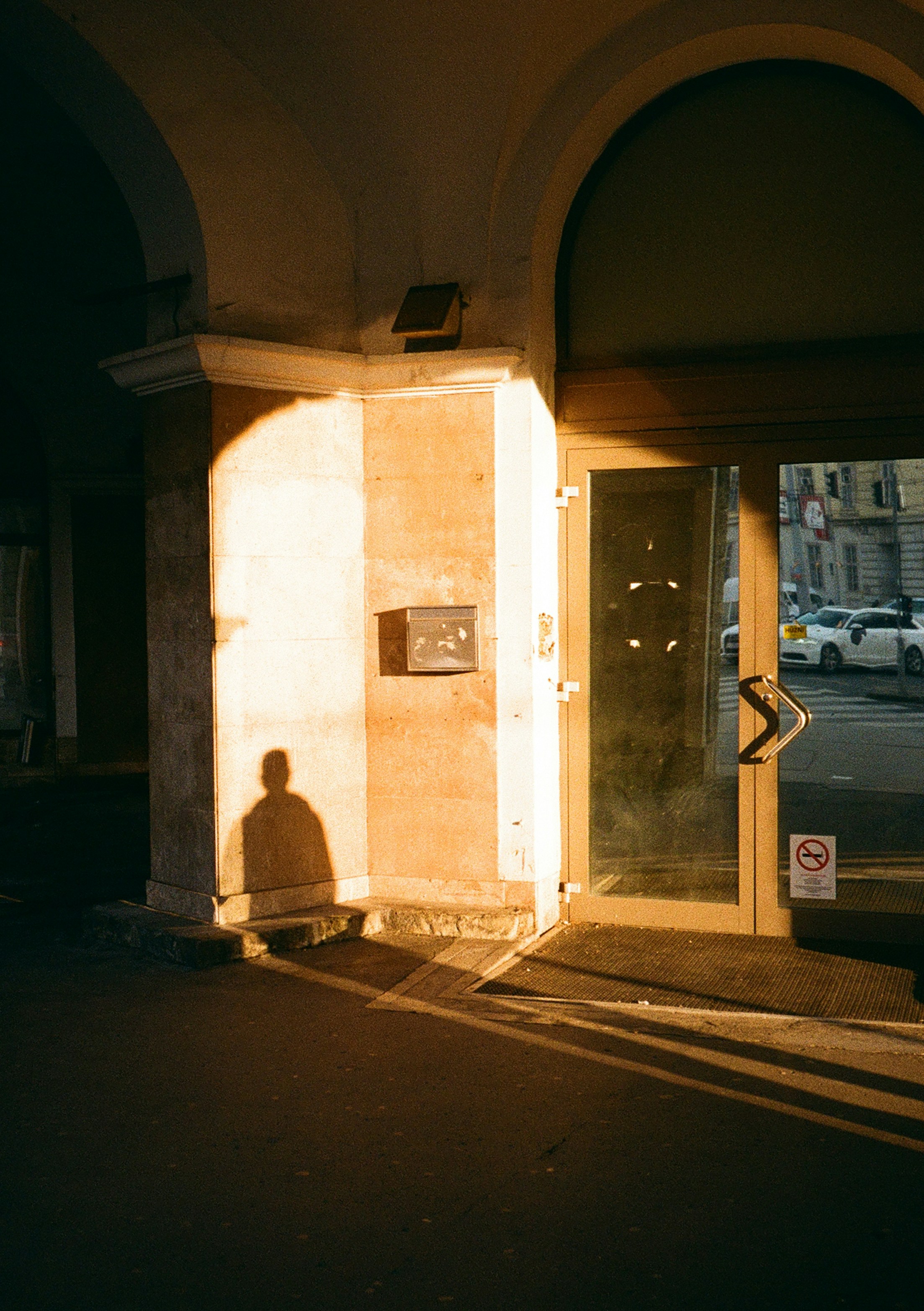 A shadow walks into a golden doorway. photo – Free Street photography ...