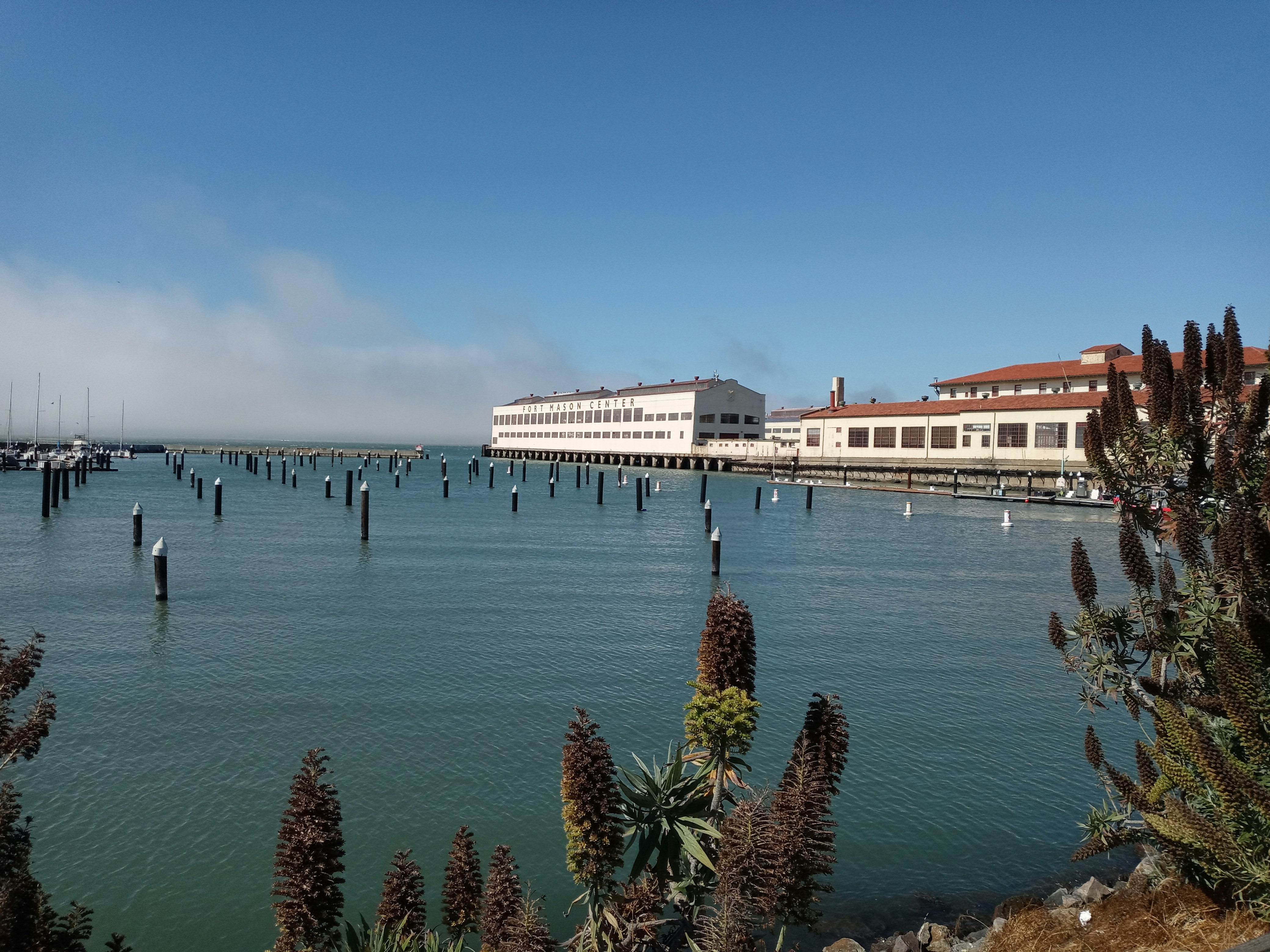 Fort Mason Center - San Francisco, California | Harbor view with buildings and foggy sky.