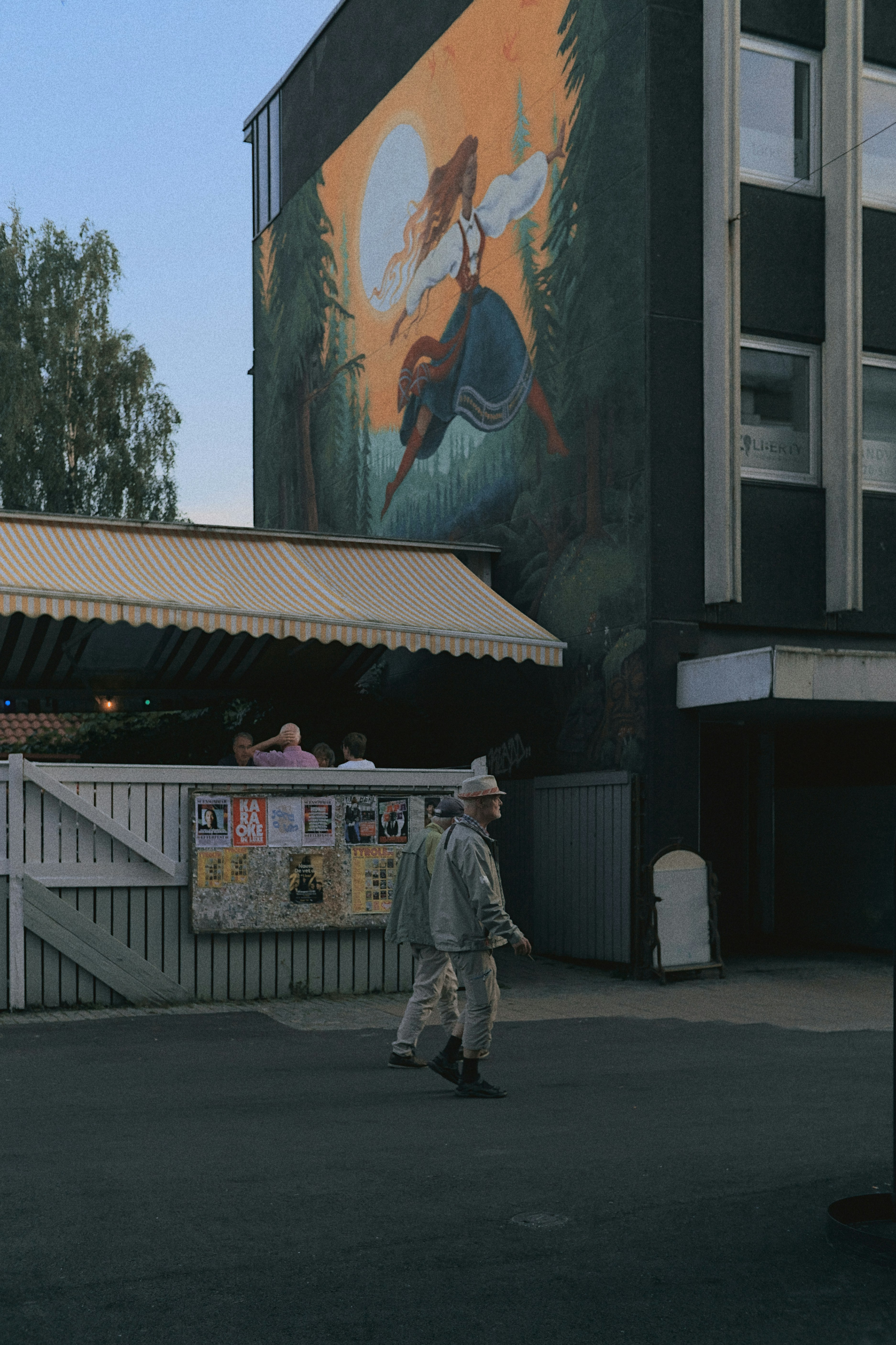 A mural decorates the wall of a building.