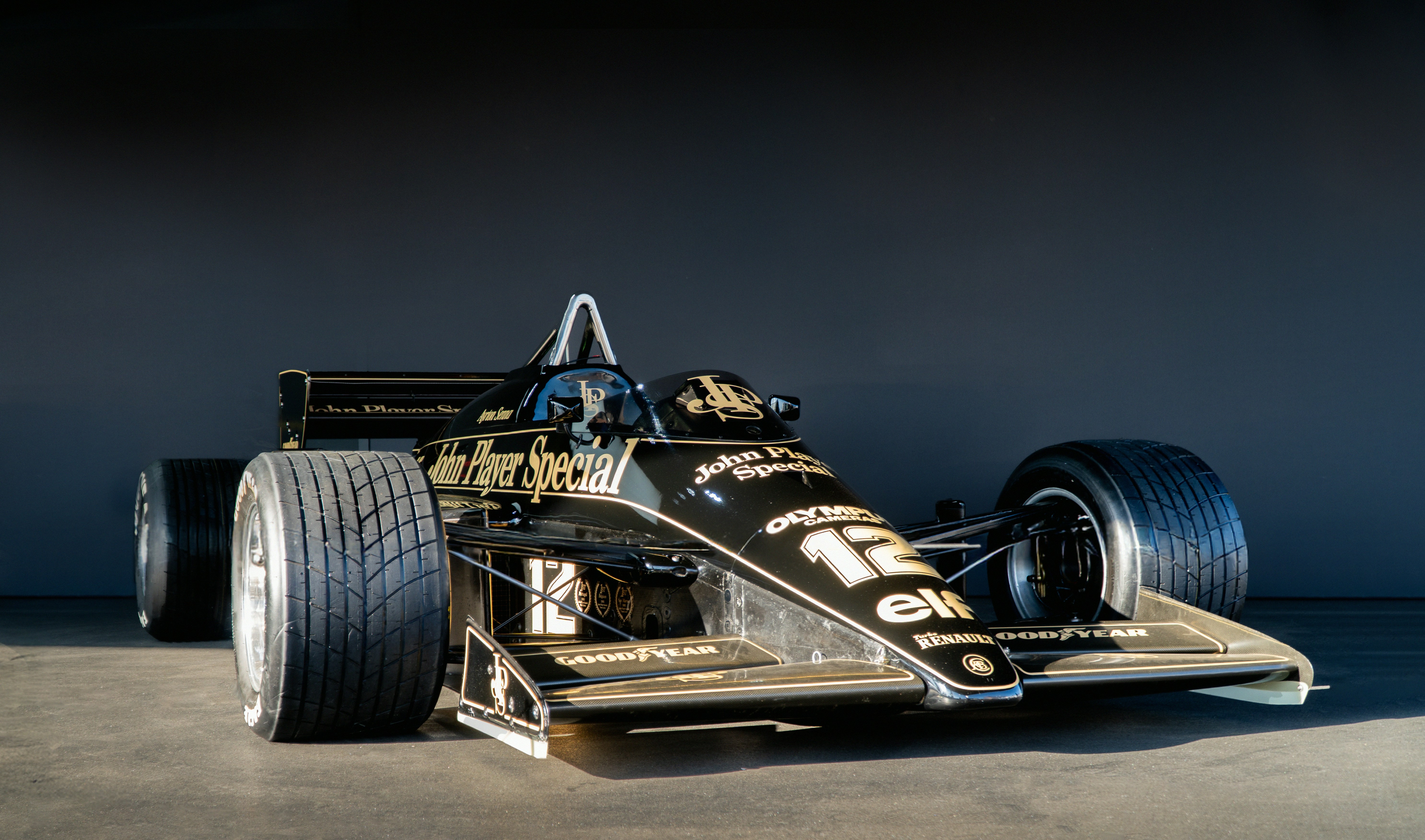 Classic racing car displayed against a minimalist backdrop, showcasing its sleek design and iconic livery.
