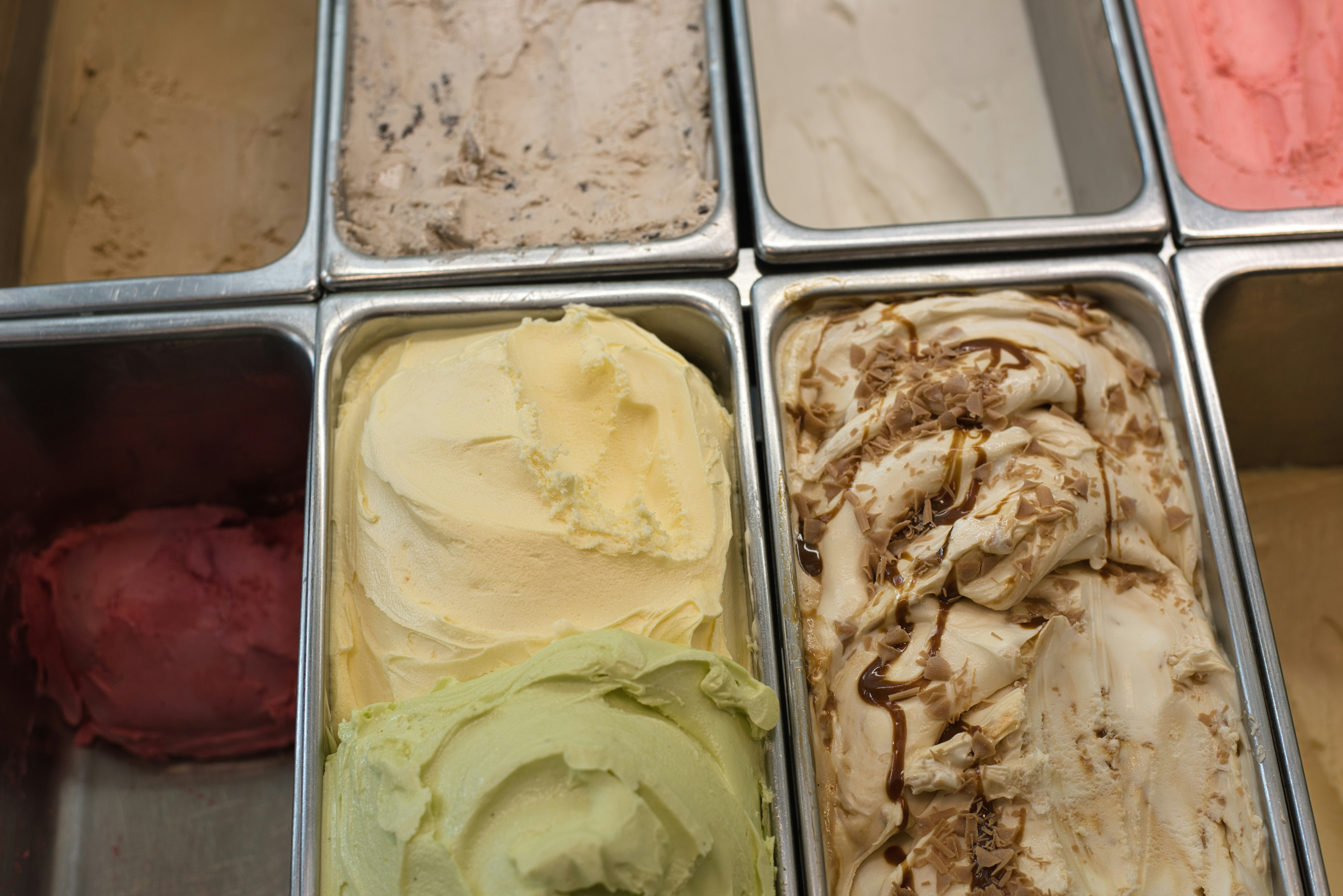 Ice cream tubs filled with various delicious flavors. photo – Free Ice ...