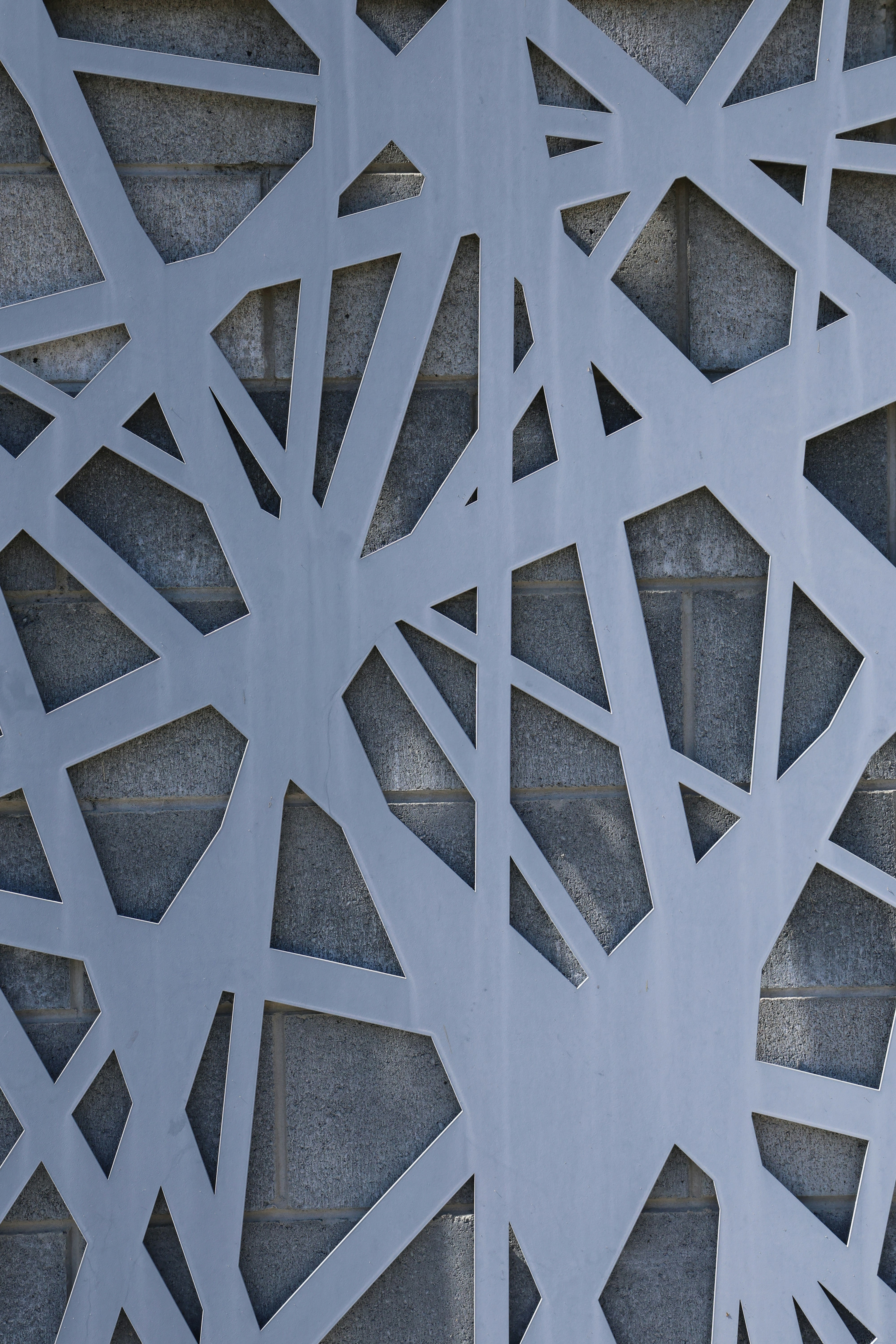 Geometric cutouts against brick wall. photo – Free Background Image on ...