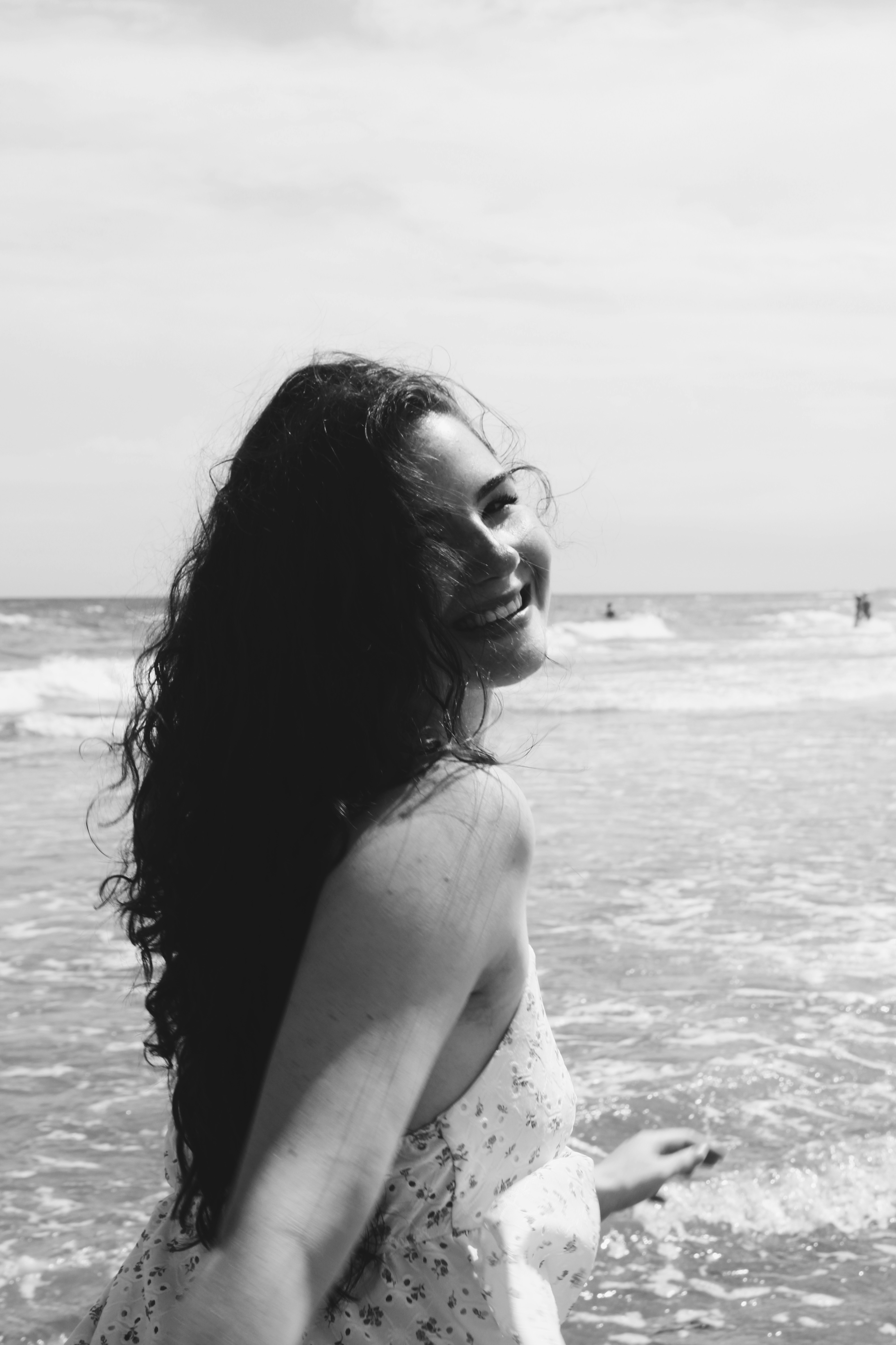Happy woman enjoying the ocean on a sunny day.