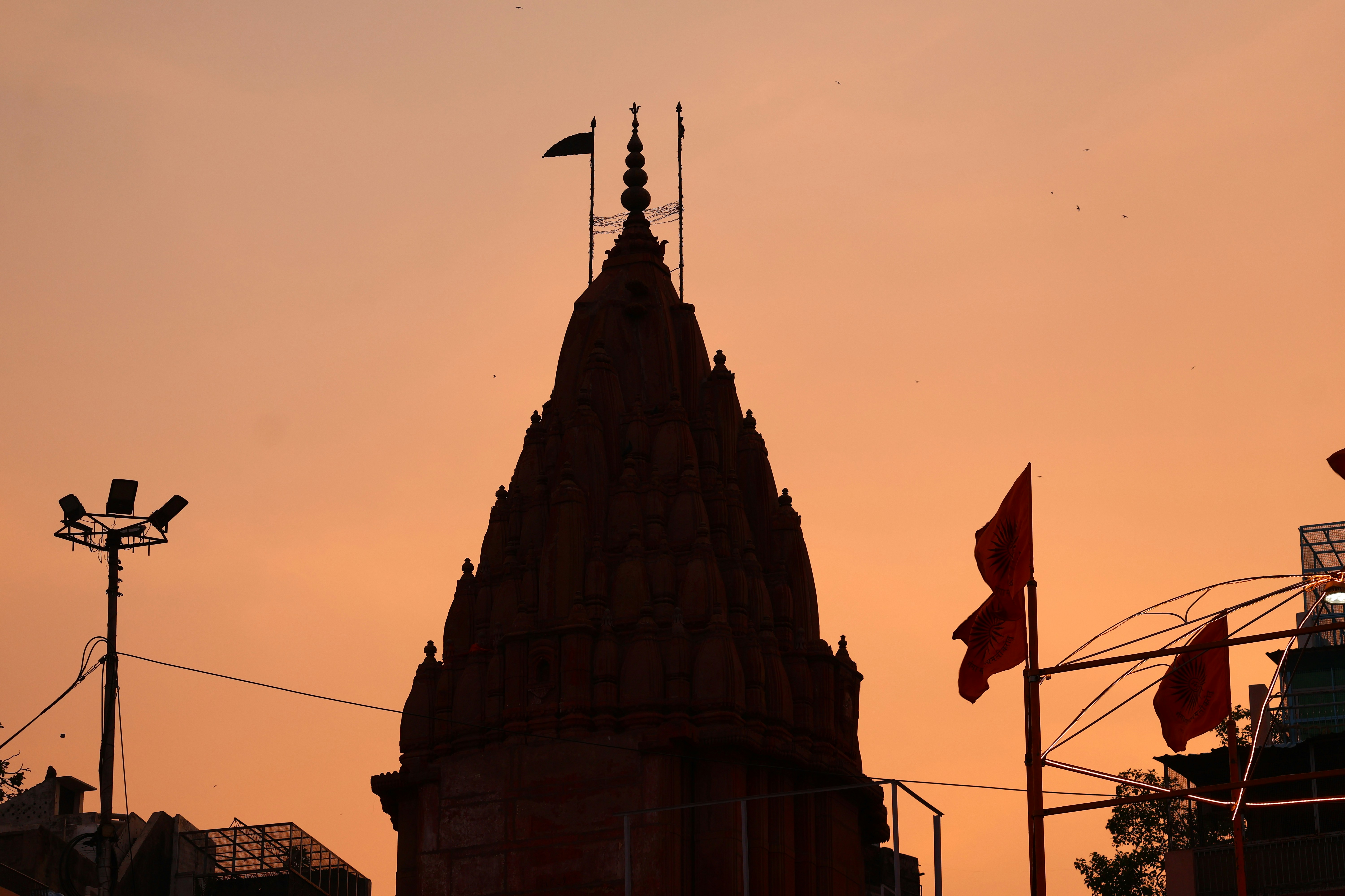 A temple silhouette against the orange sky.