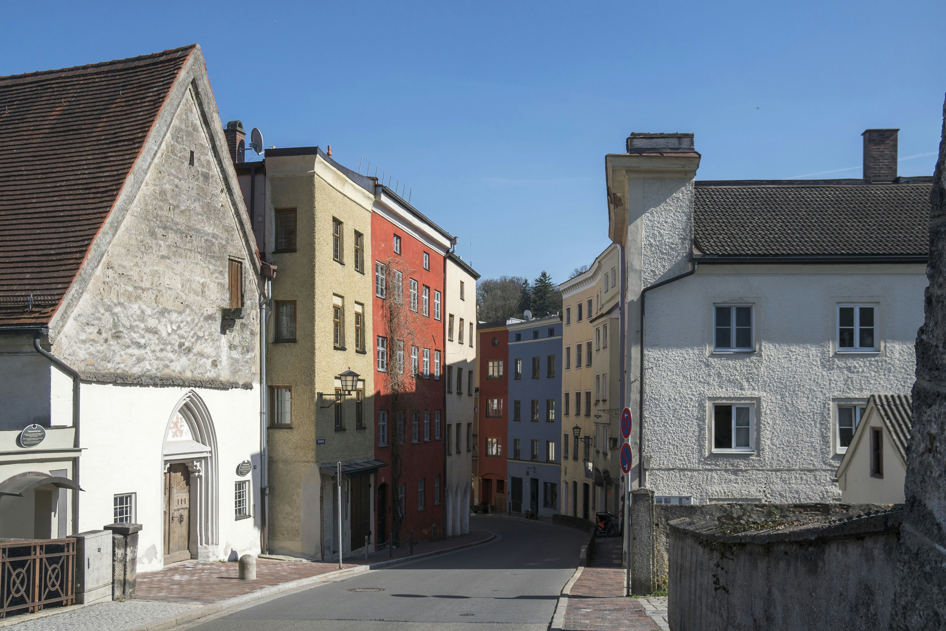 A narrow street lined with colorful buildings.