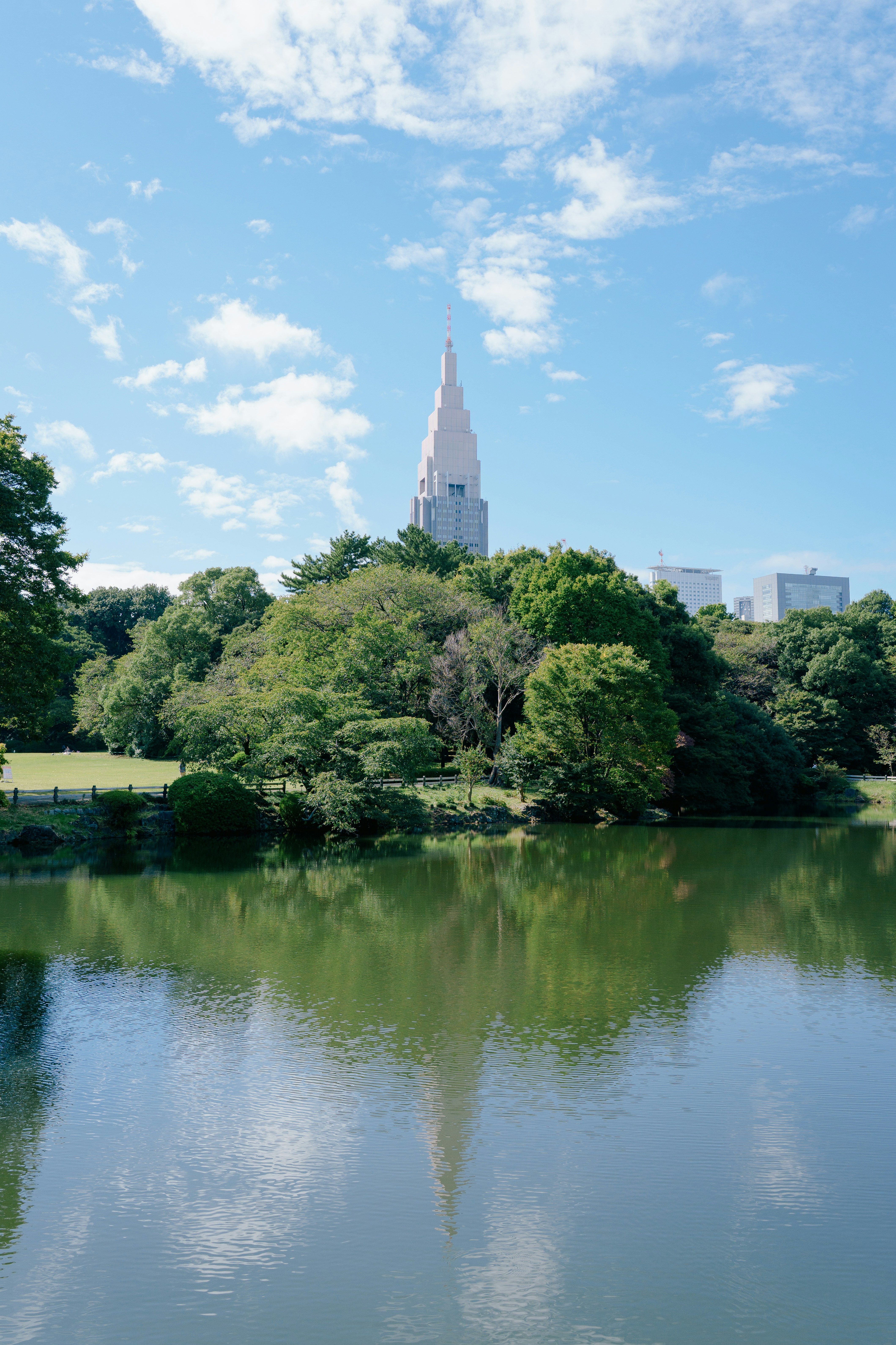 A building reflects in the serene lake's waters.